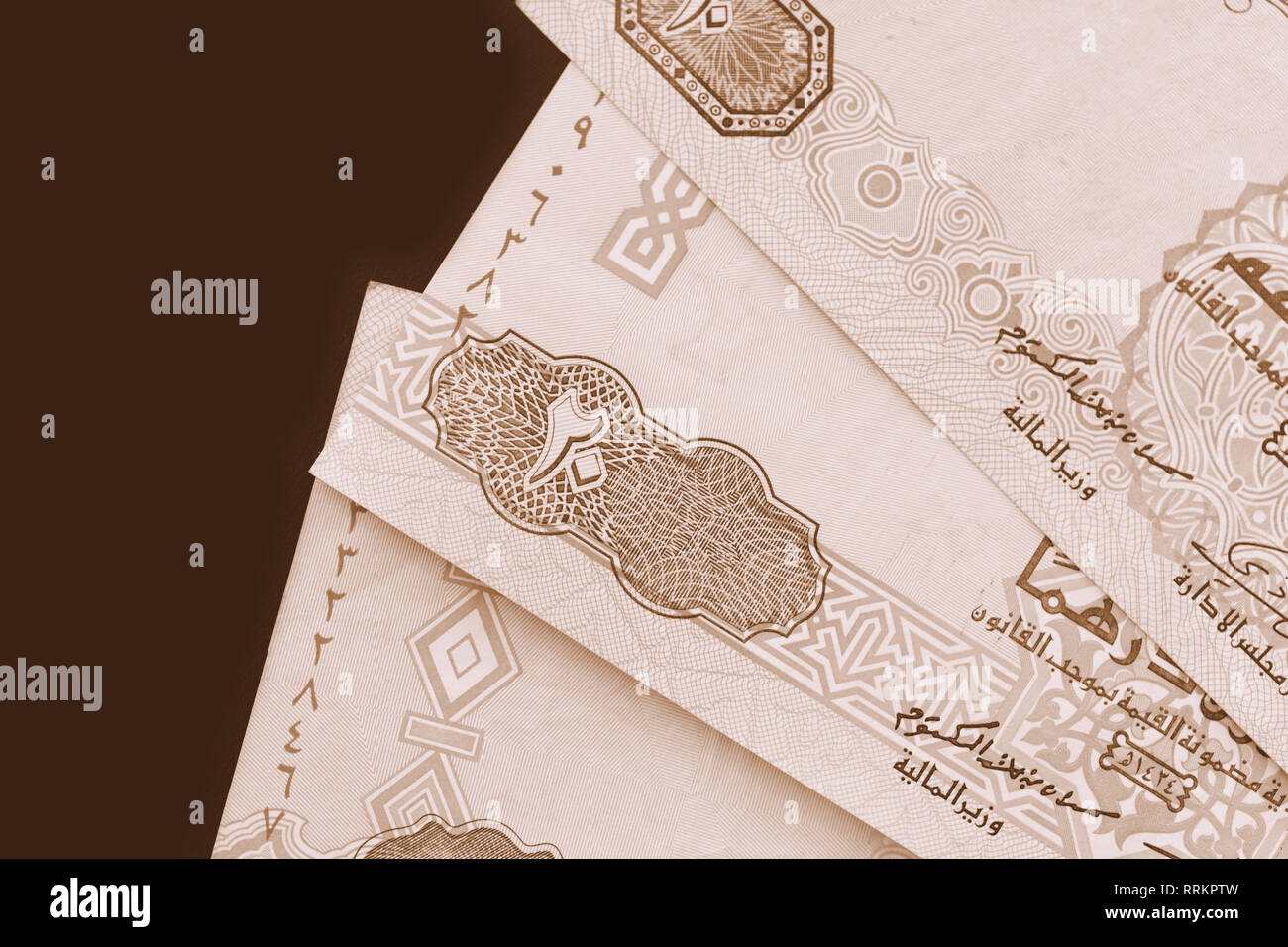 UAE dirham currency background close up. Brown color toned Stock Photo ...