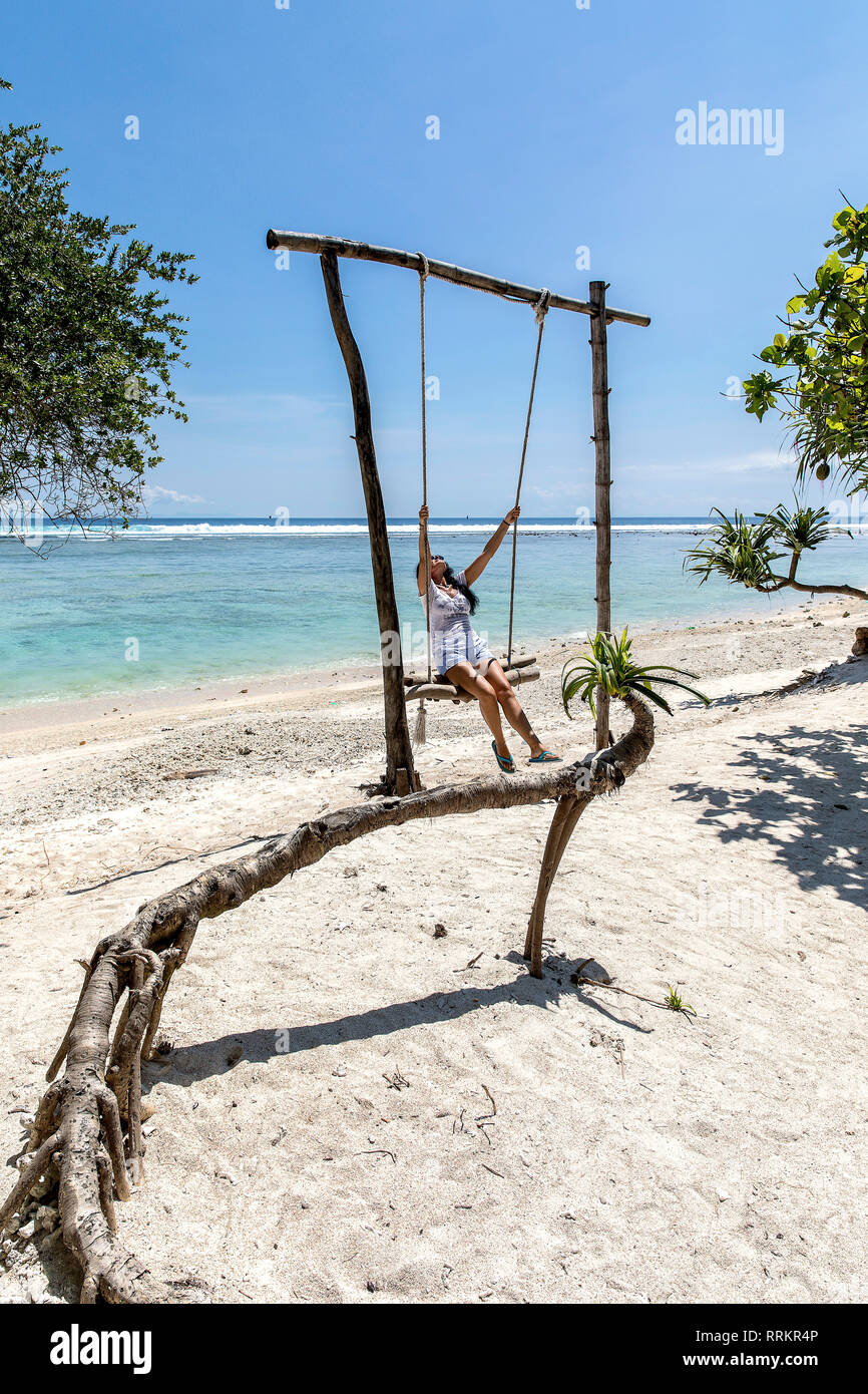 indonesia, gili trawangan island Young woman swinging on swing Stock ...