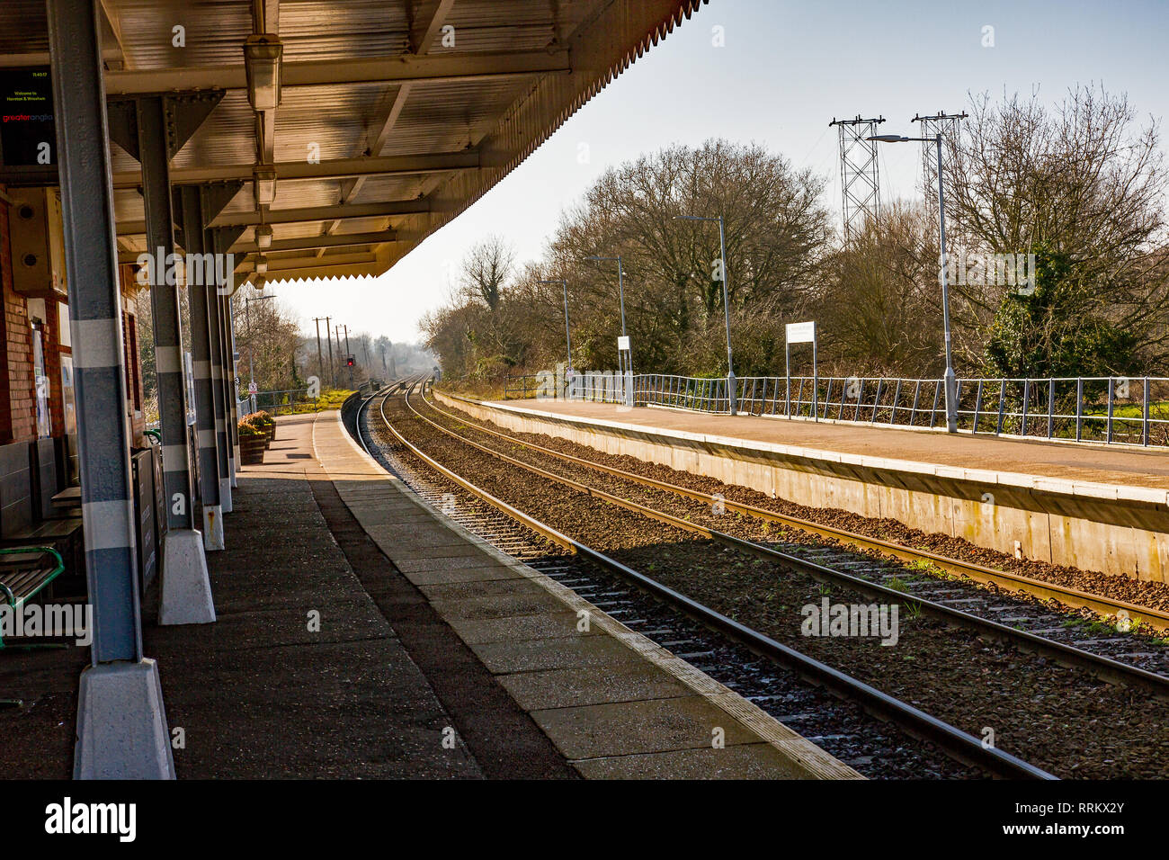 On a concrete platform waiting for the train to arrive Stock Photo - Alamy