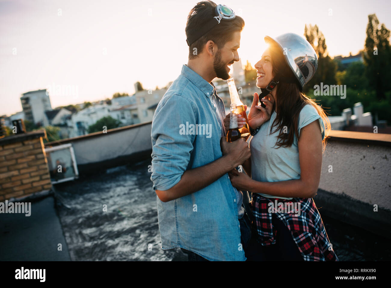 Couple in love enjoying in sunset in a terrace Stock Photo - Alamy