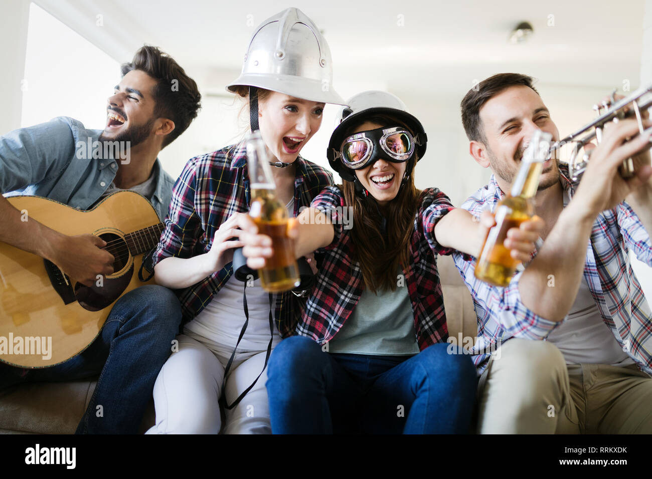 Friends having fun and partying in house and playing music Stock Photo ...