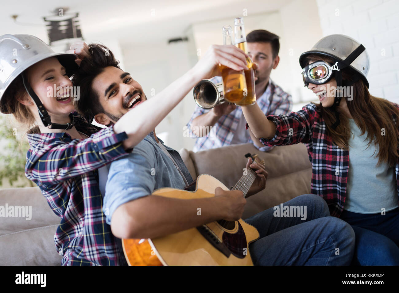 Cheerful friends having party and drinking beer Stock Photo - Alamy