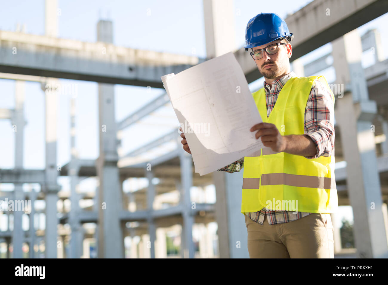 Picture of construction site engineer looking at plan Stock Photo - Alamy