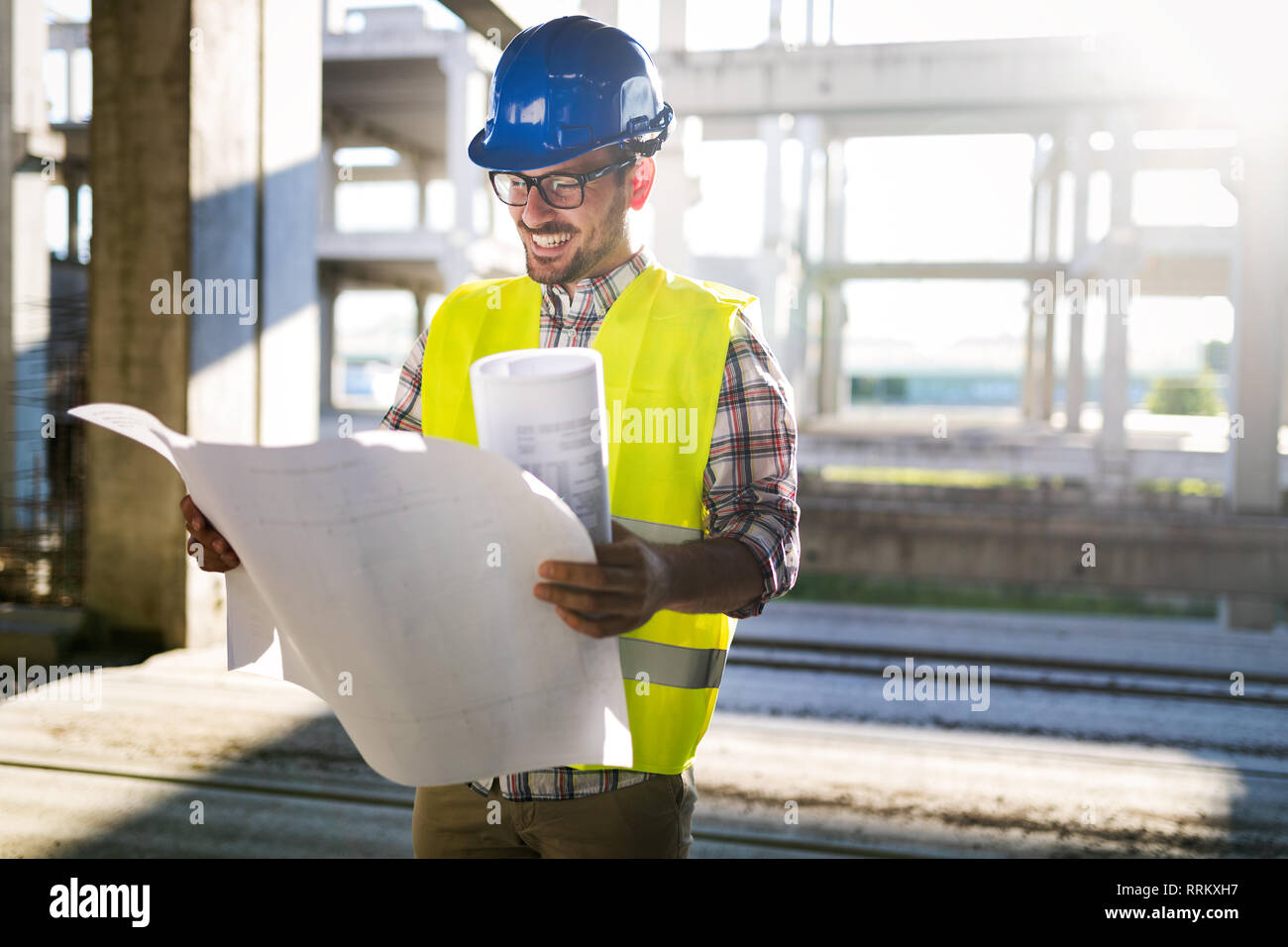 Picture of construction site engineer looking at plan Stock Photo - Alamy