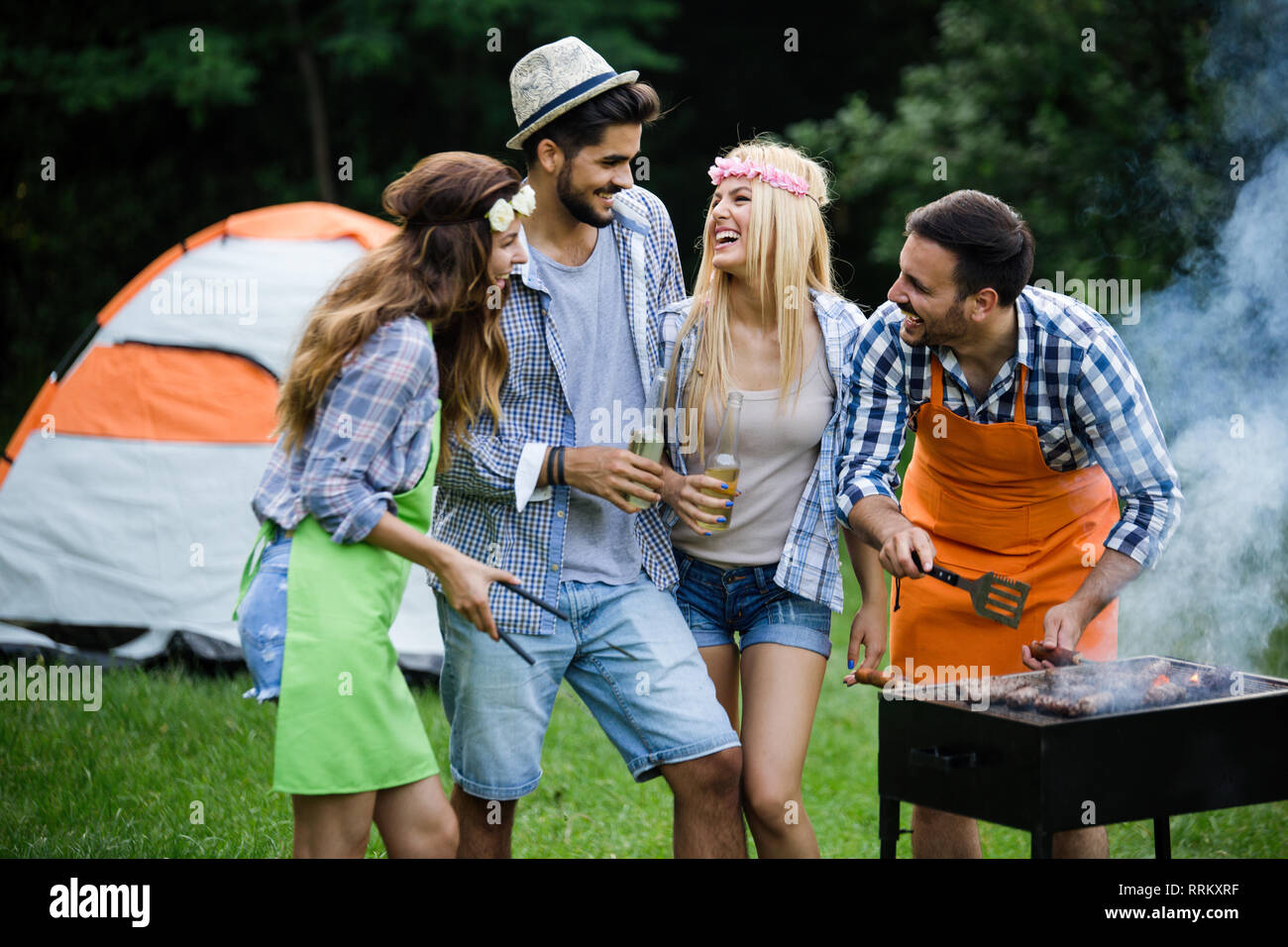 Group of friends making barbecue in the nature Stock Photo - Alamy