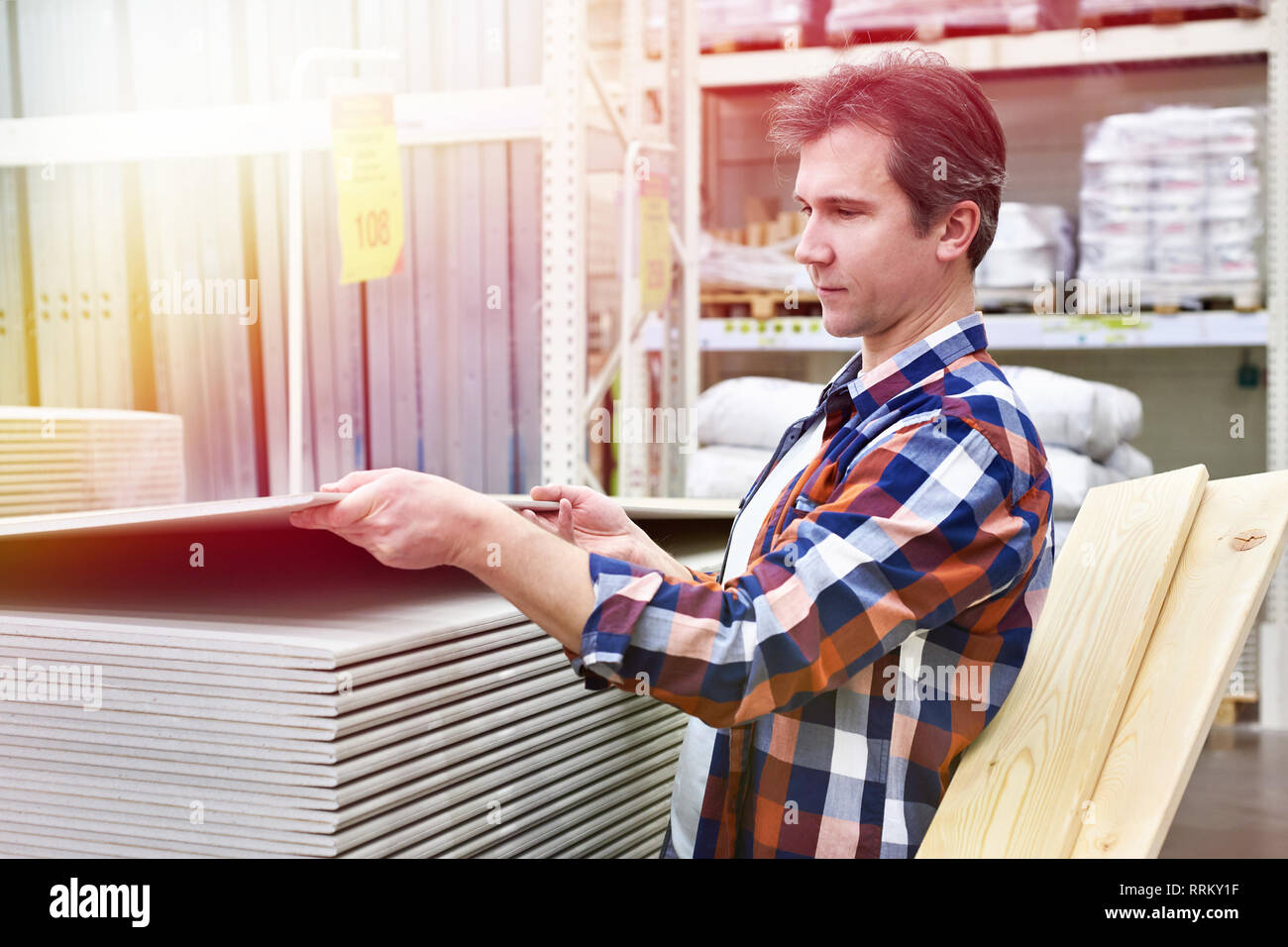 Man chooses and buys drywall in a construction supermarket Stock Photo ...