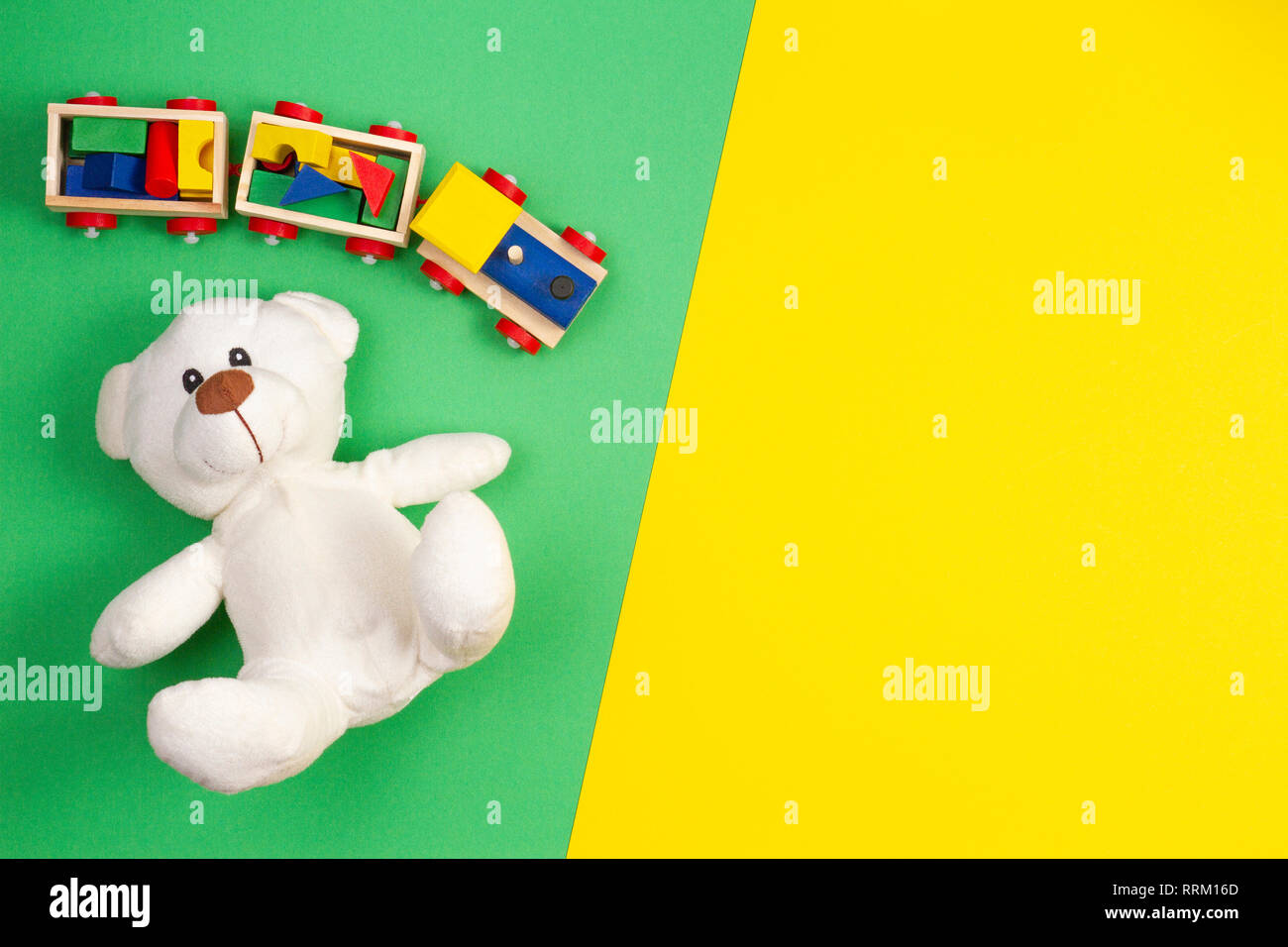 Baby kids toys background. White teddy bear and wooden toy train on ...