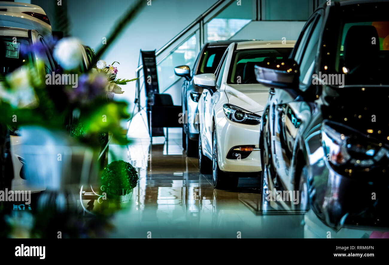 New luxury shiny compact car parked in modern showroom. Car dealership ...