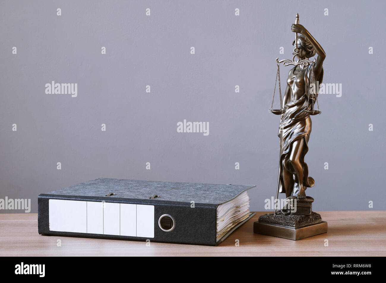 lady justice or justitia statue and file folder on desk Stock Photo - Alamy