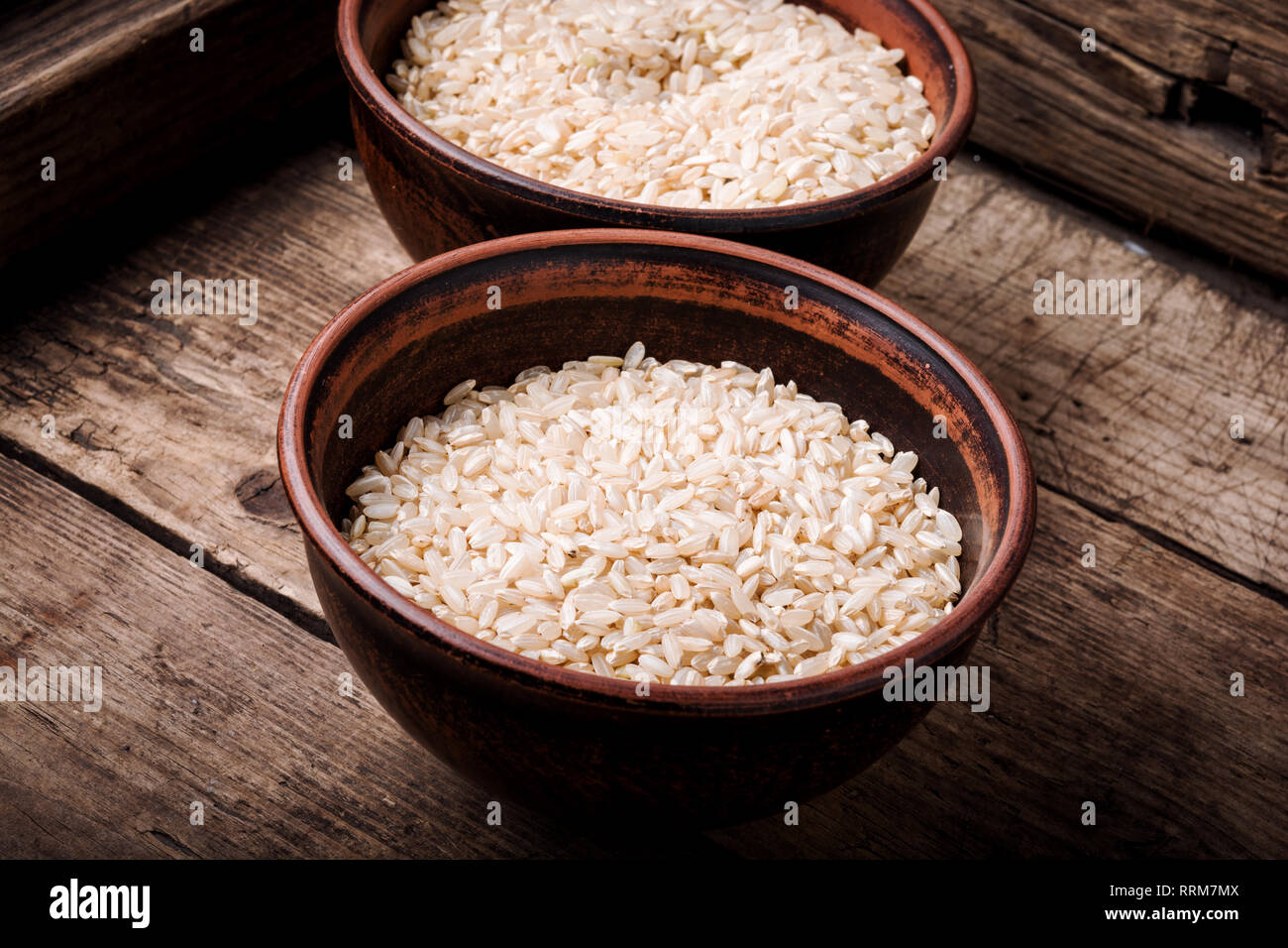 Raw grain white rice in a ceramic bowl.Healthy food Stock Photo - Alamy