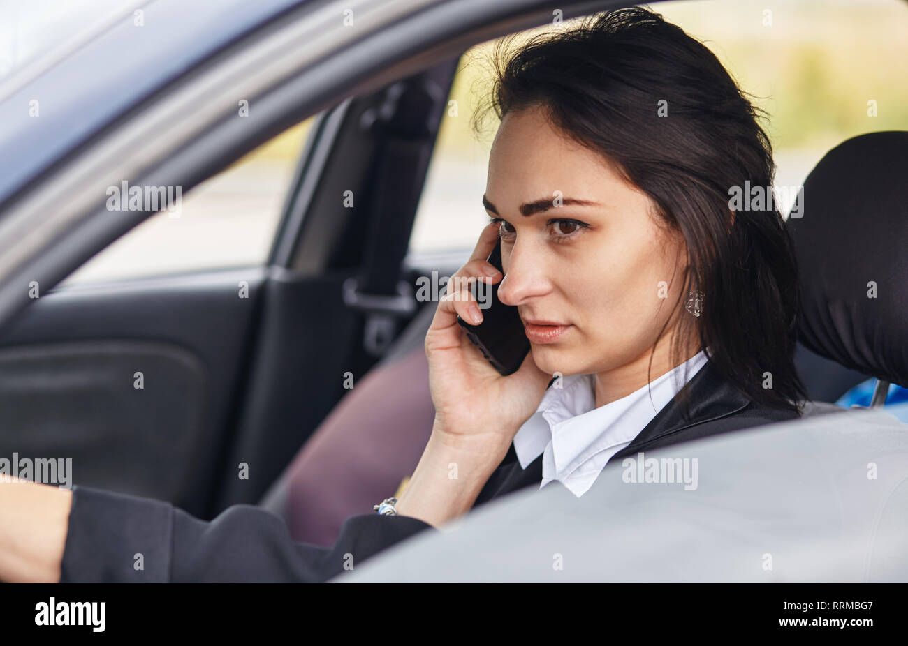 Woman driver using her mobile phone while driving car Stock Photo - Alamy