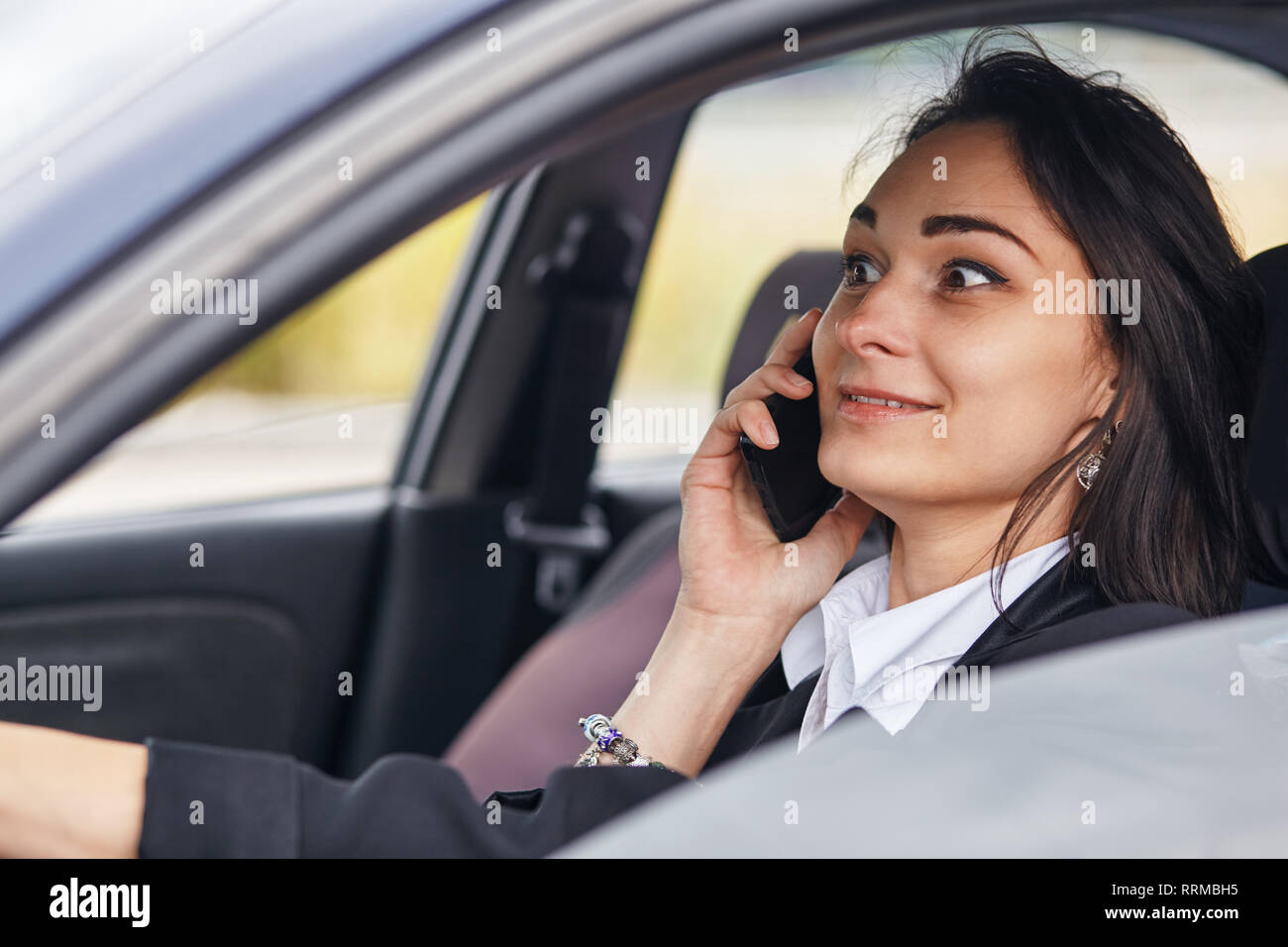 Woman driver using her mobile phone while driving car Stock Photo - Alamy