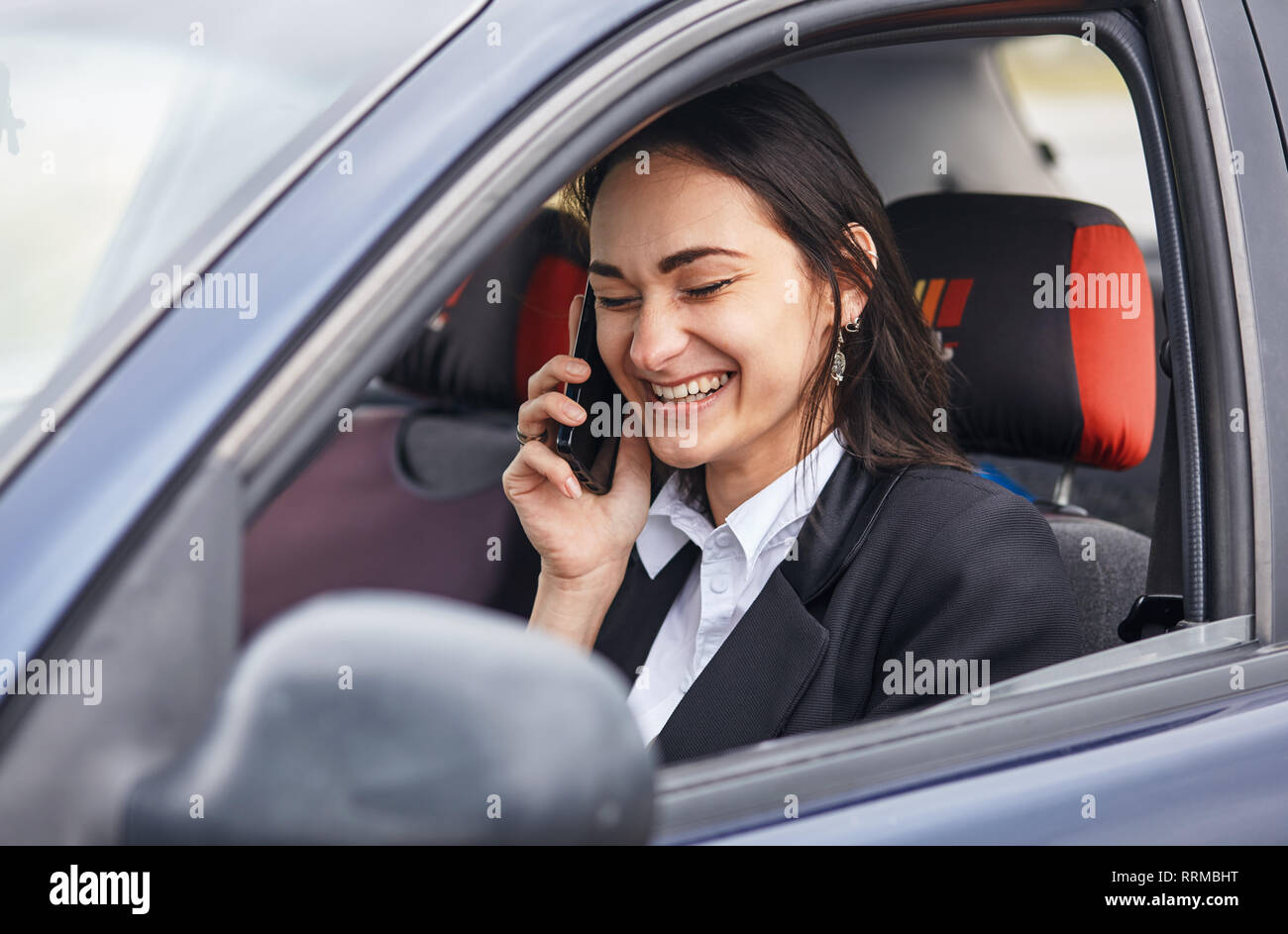 Woman driver using her mobile phone while driving car Stock Photo - Alamy