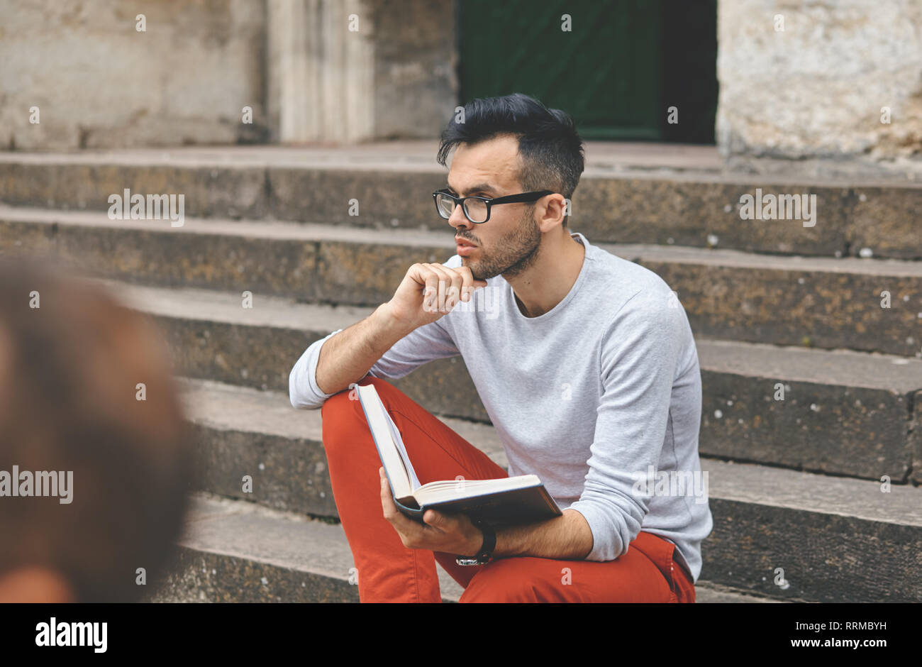 Focused on reading a student book near a university. A nice guy thinks ...
