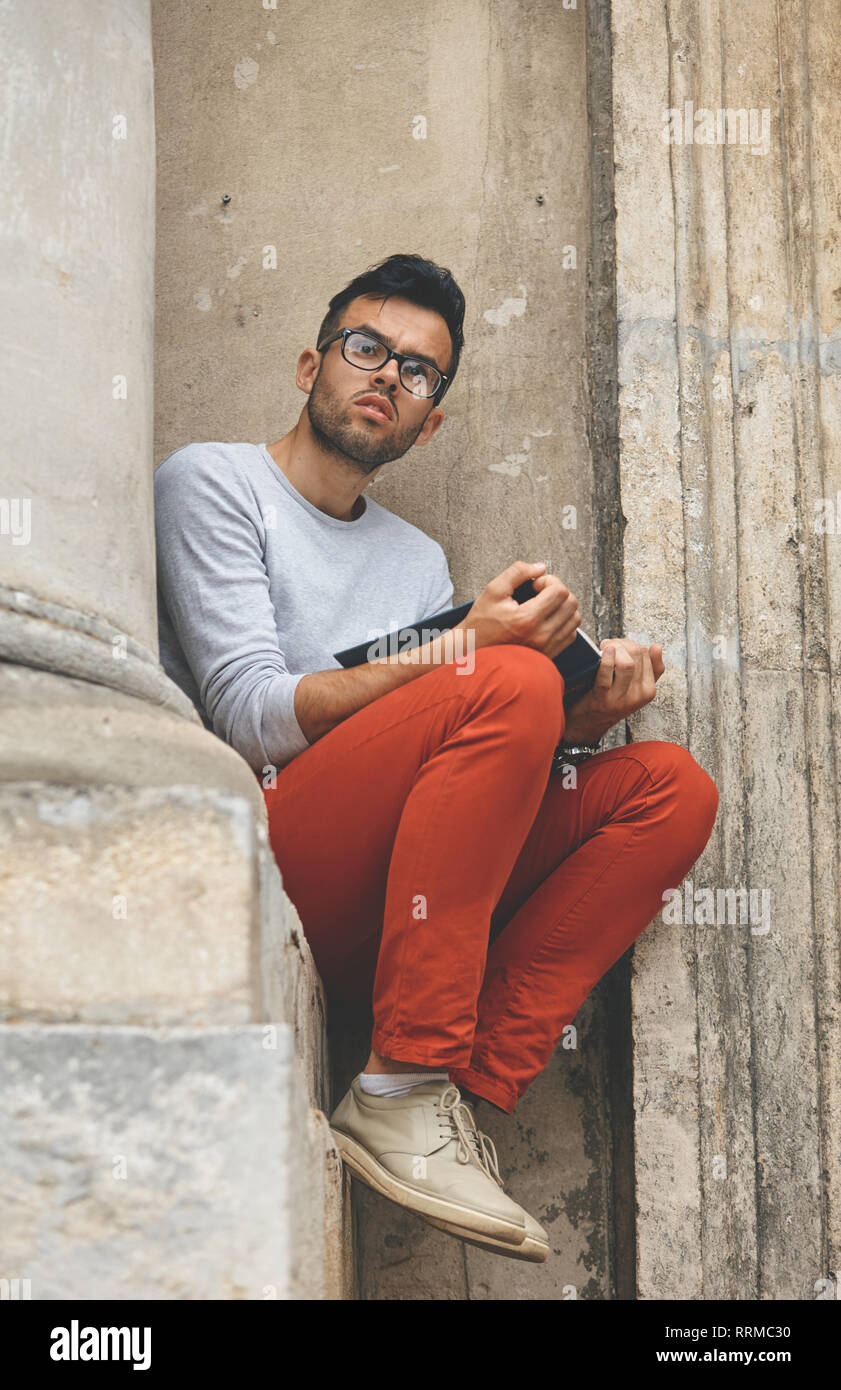 Focused on reading a student book near a university. A nice guy thinks ...