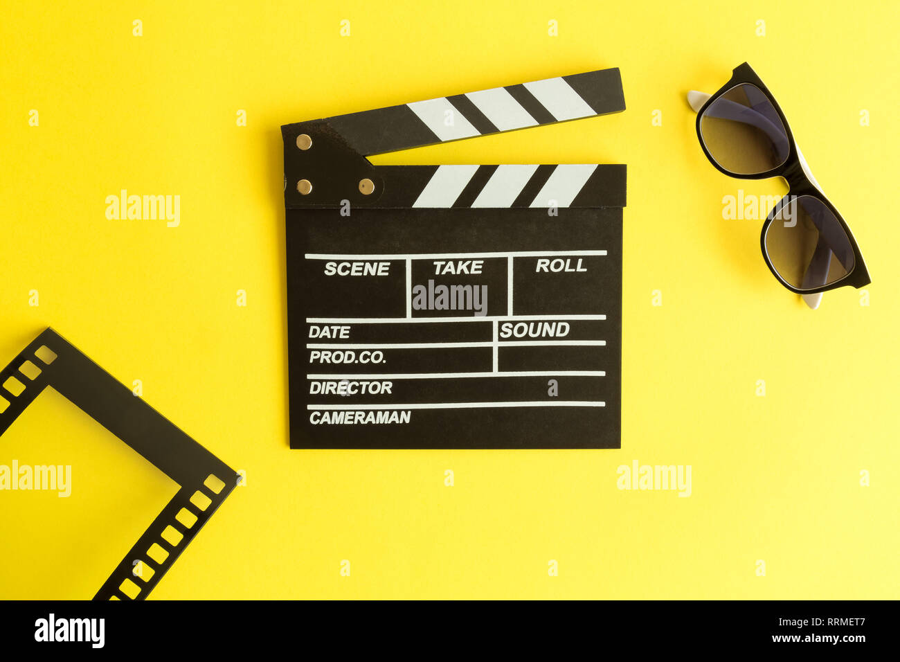 Flat lay of clapper board and glasses with film strip frame isolated on ...