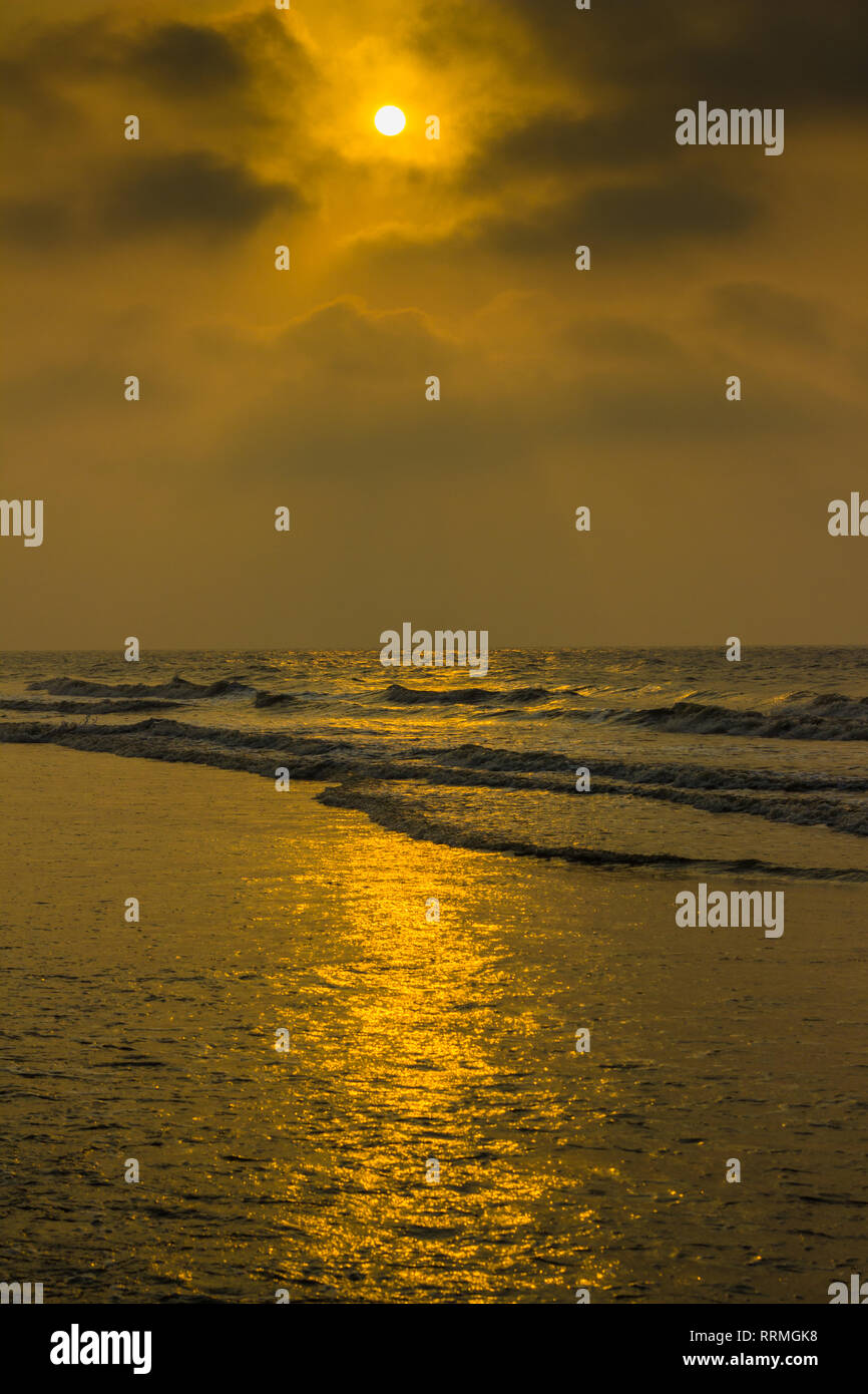 golden sunrise sunset twilight hour. sun rays reflecting on sea water ...