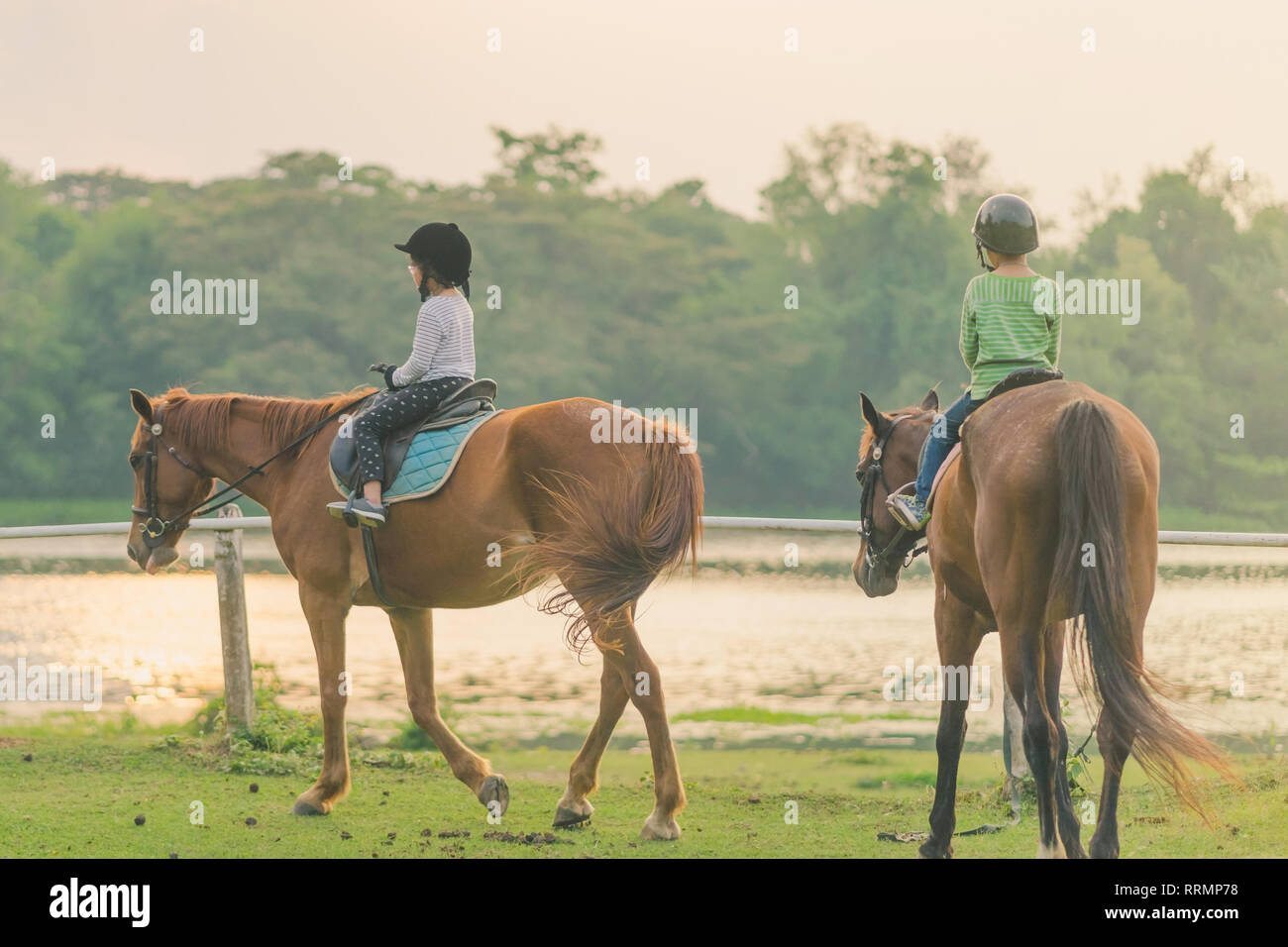 Asian child riding horse helmet hi-res stock photography and images - Alamy