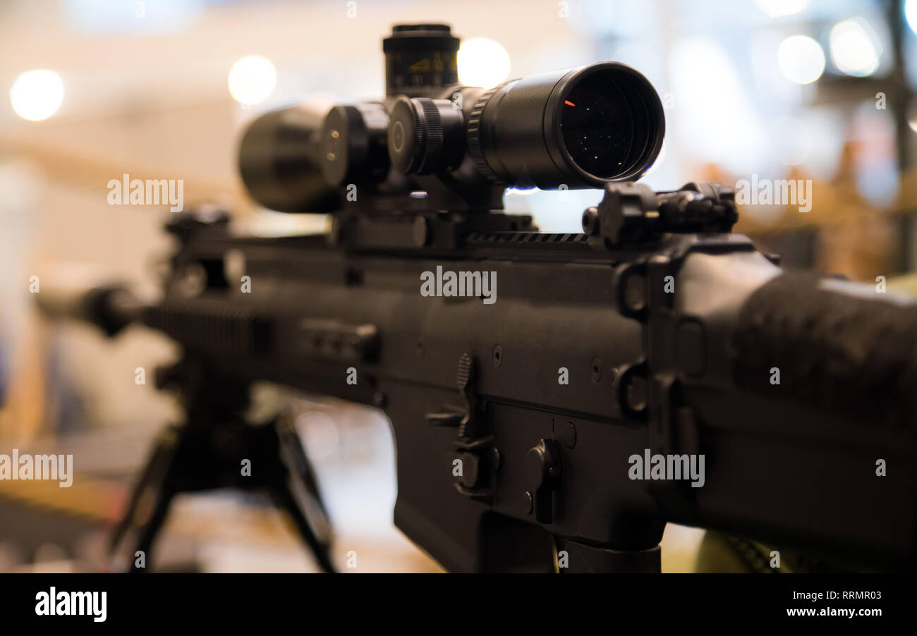 Young soldier aiming machine gun at target during military training in ...