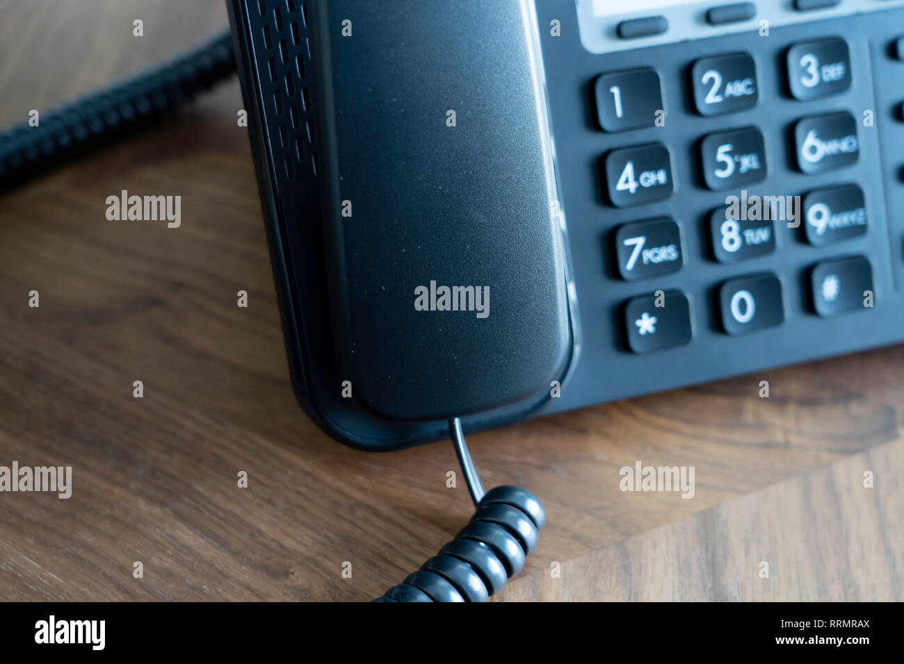 Office Telephone console on wood table Stock Photo - Alamy