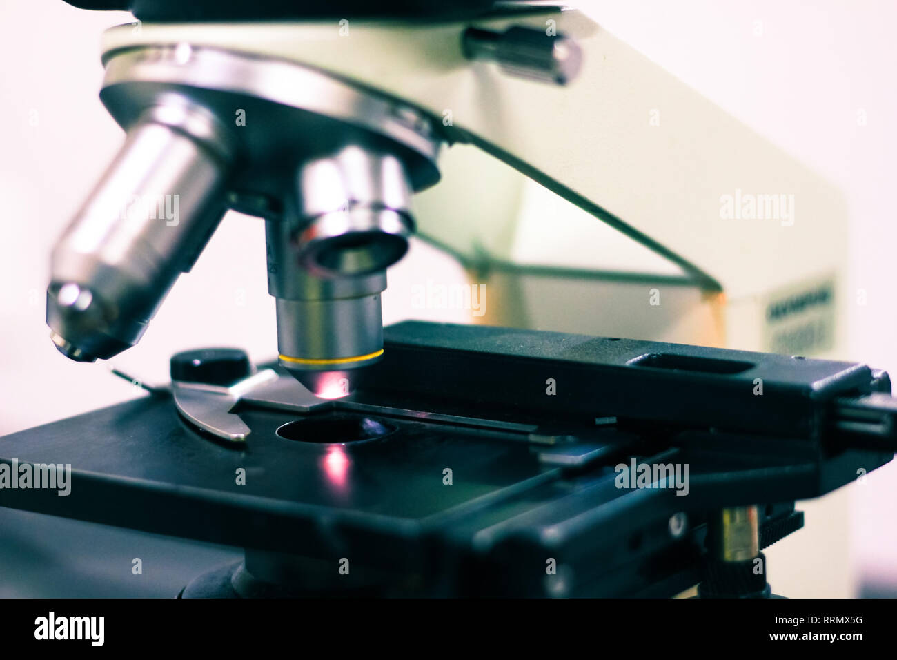 side view of a light microscope showing the light on and optical eye ...