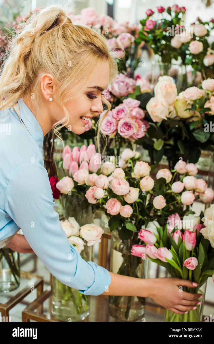 beautiful smiling woman choosing flowers in flower shop Stock Photo - Alamy