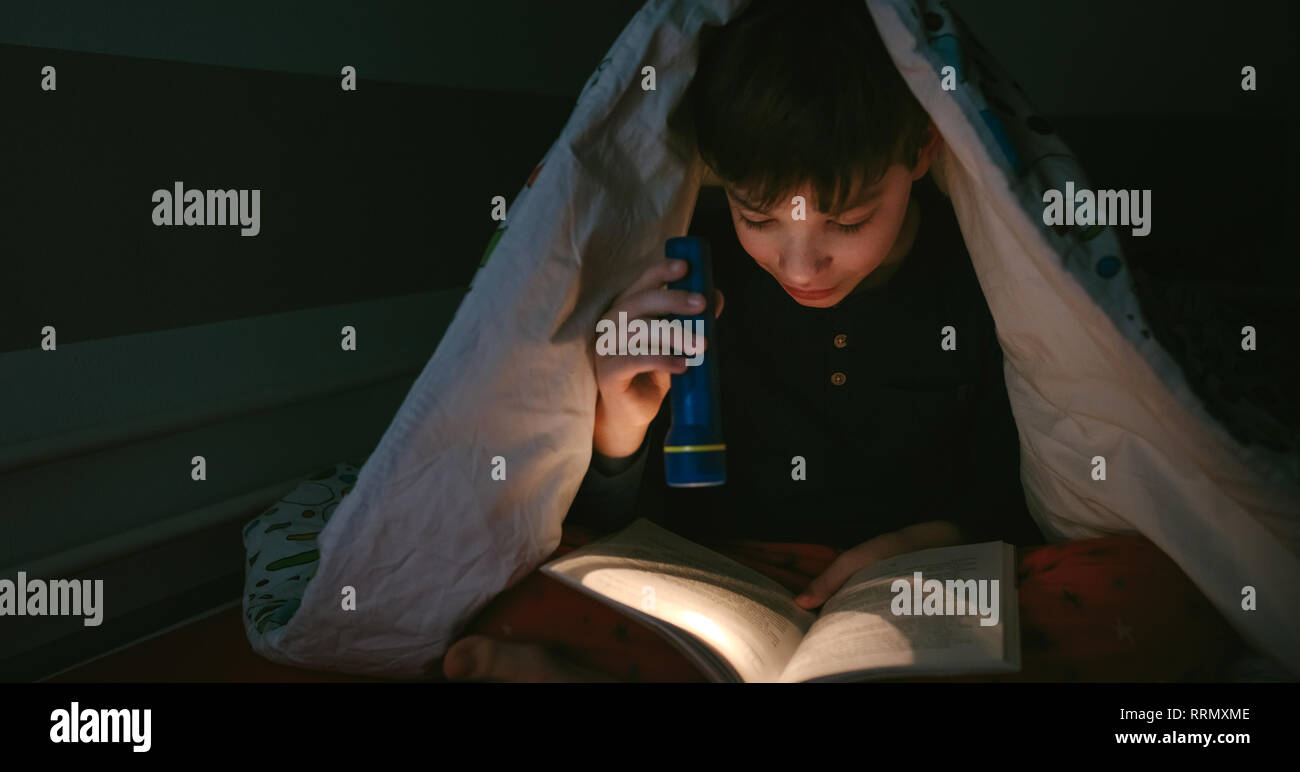 Caucasian teen boy reading book hi-res stock photography and images - Alamy