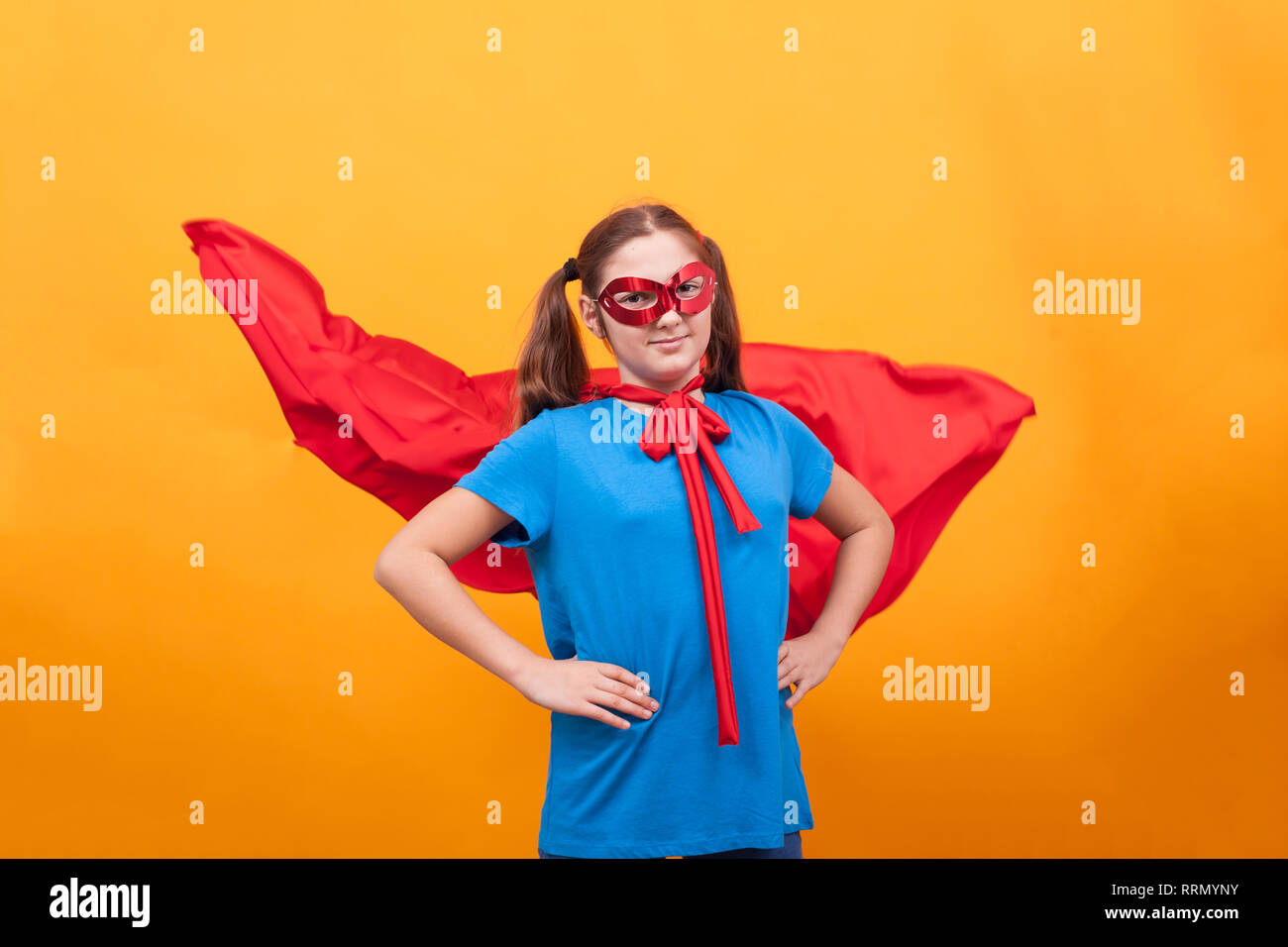 Little girl in super hero costume ready to save the world from bad guys ...