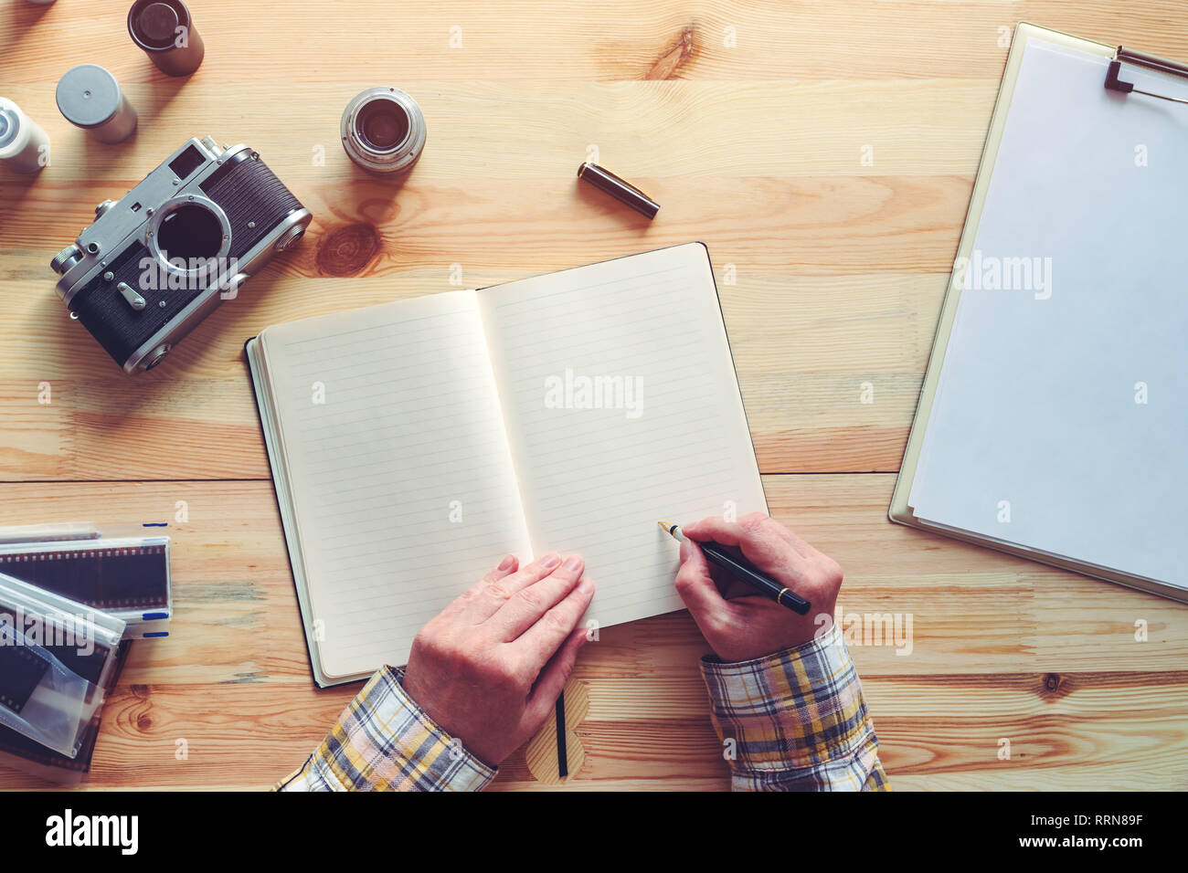 Photographer planning a photo shooting, writing notes and to do list in ...