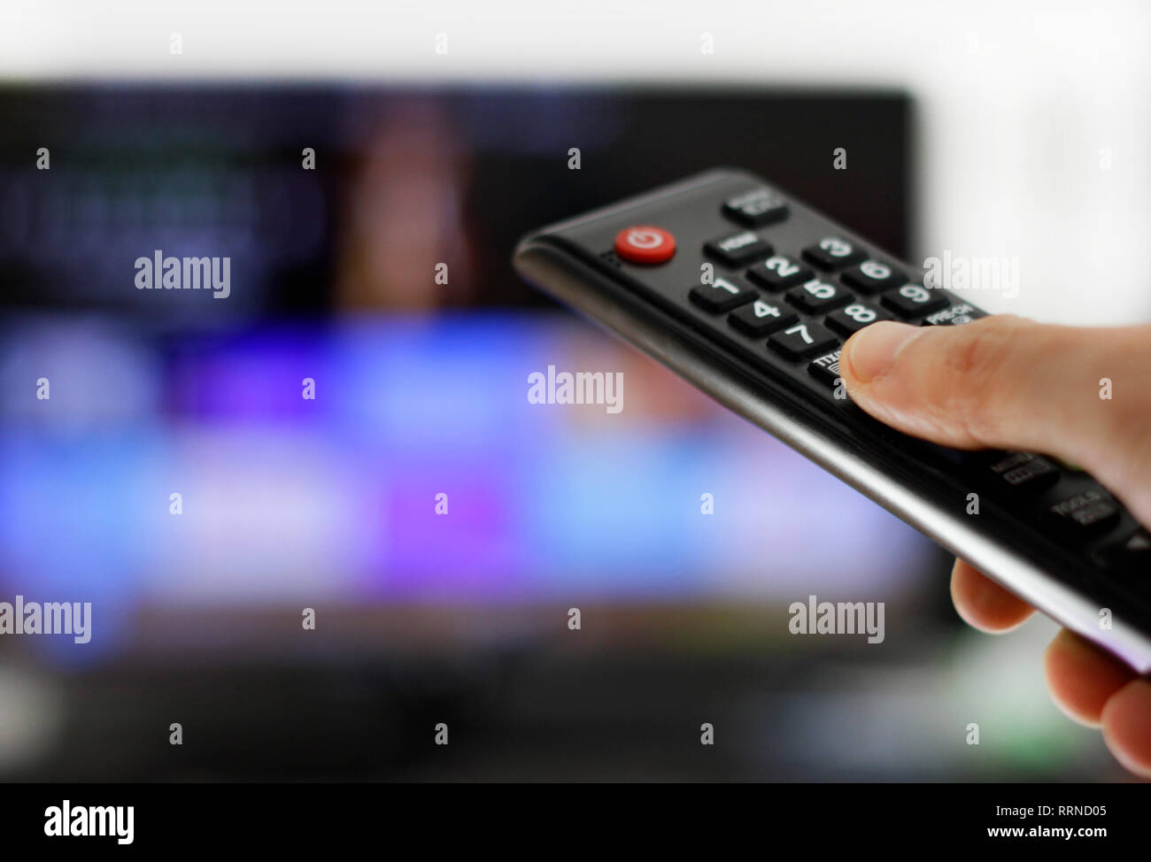 Tv watching netflix holding remote control hi-res stock photography and ...