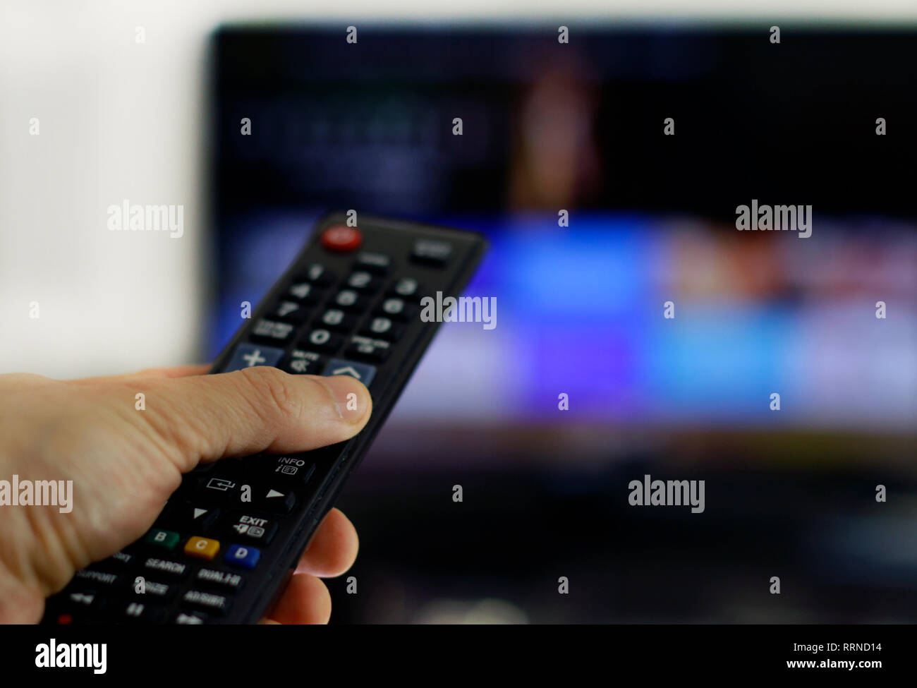 Tv watching netflix holding remote control hi-res stock photography and ...