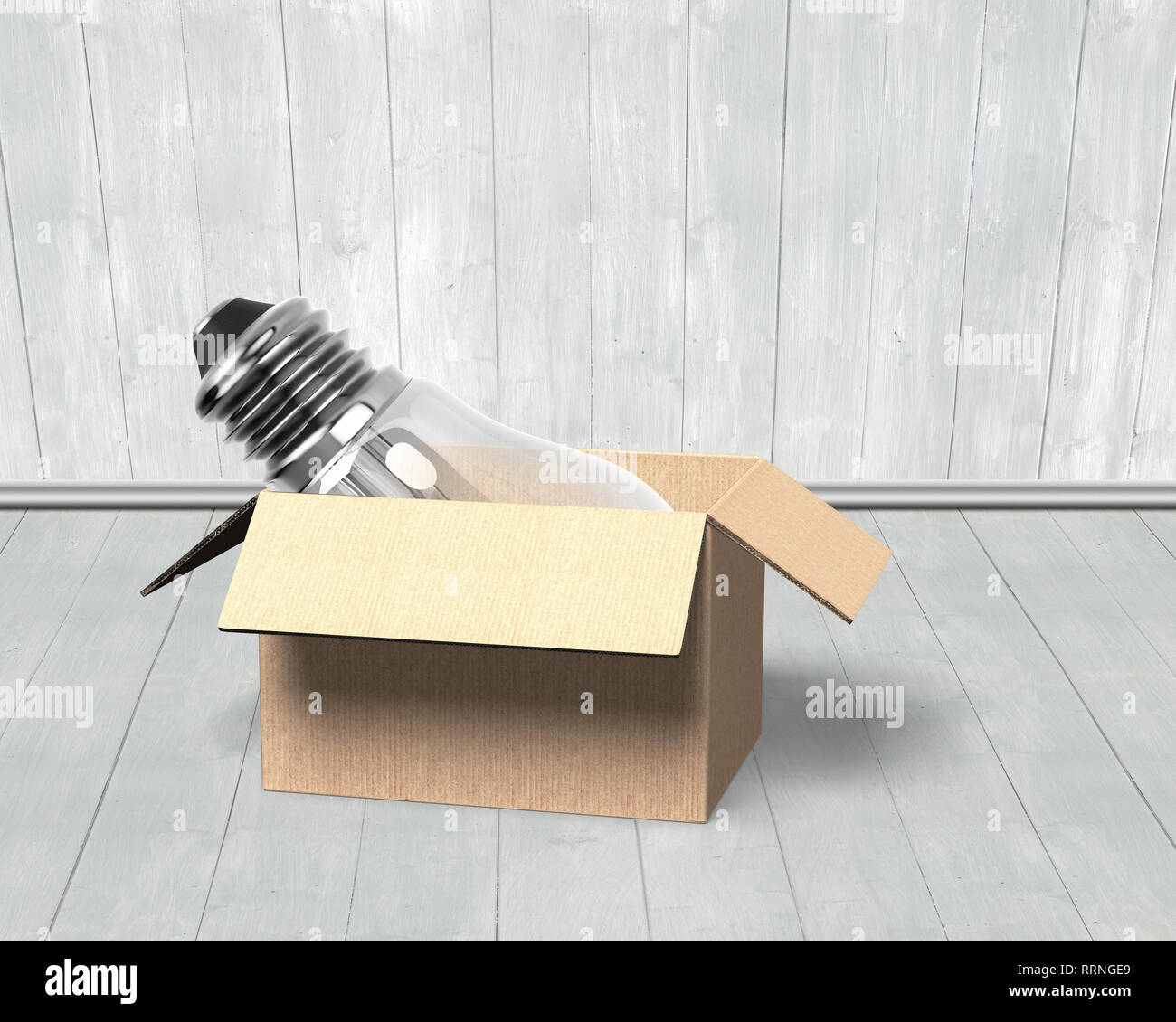 Light bulb in opened cardboard box, on wooden wall and floor indoors ...