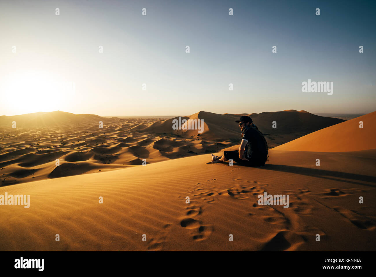Male traveler enjoying sunny sandy desert view, Sahara, Morocco Stock ...