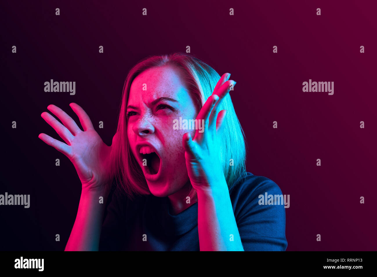 Screaming, hate, rage. Crying emotional angry woman screaming on neon ...