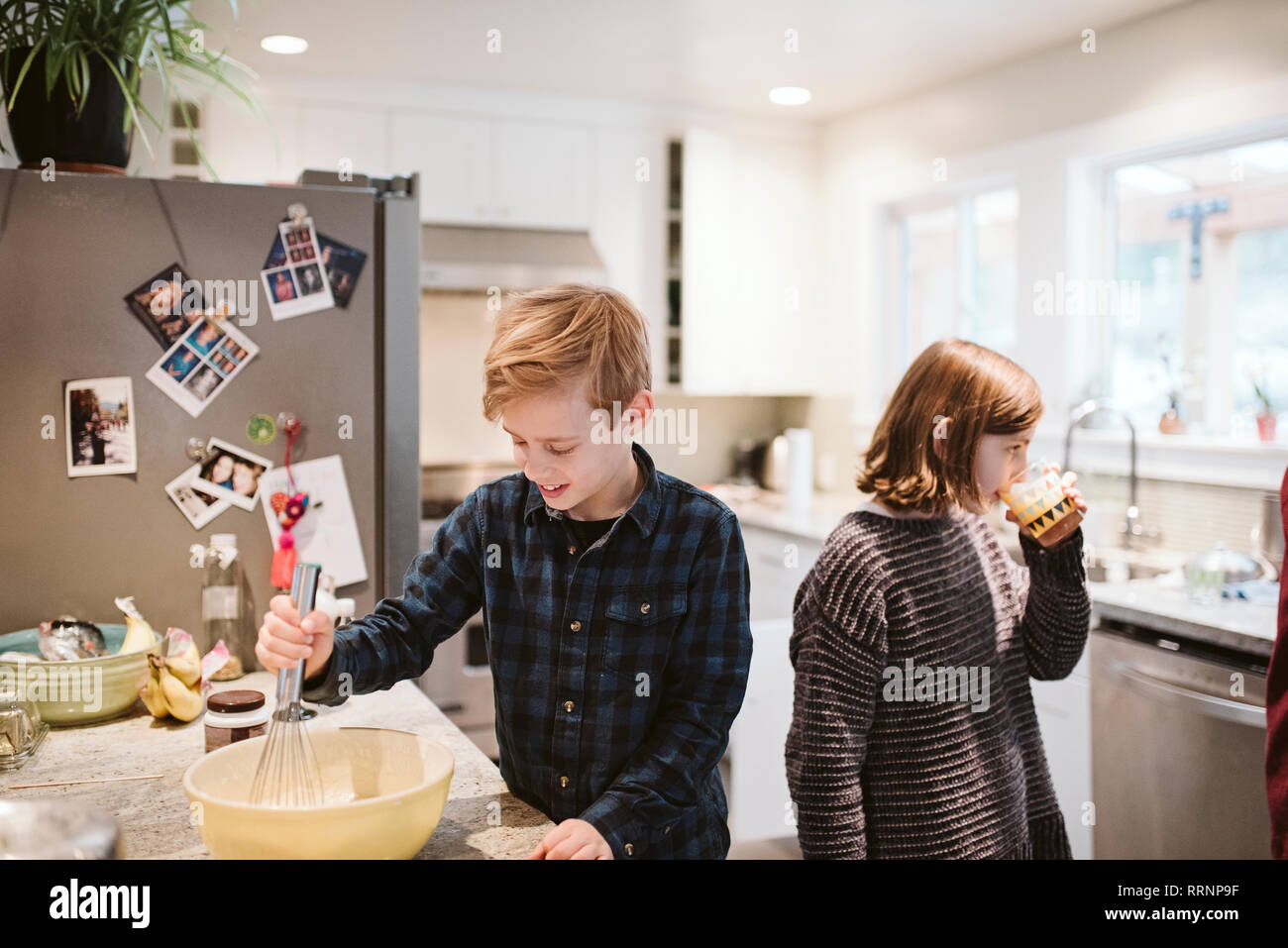 Brother and sister baking in kitchen Stock Photo - Alamy