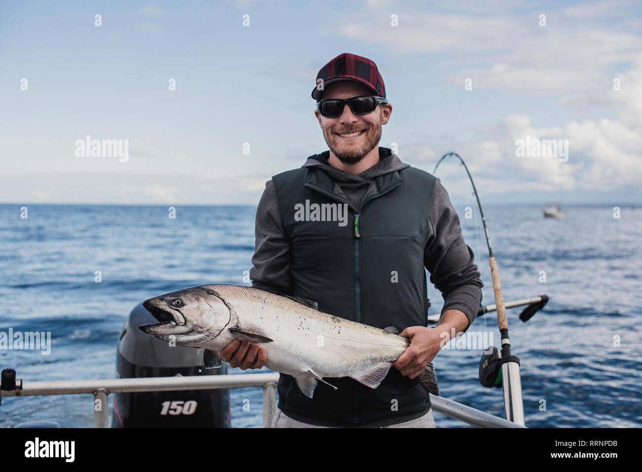 Portrait confident male fisherman catching fish Stock Photo - Alamy