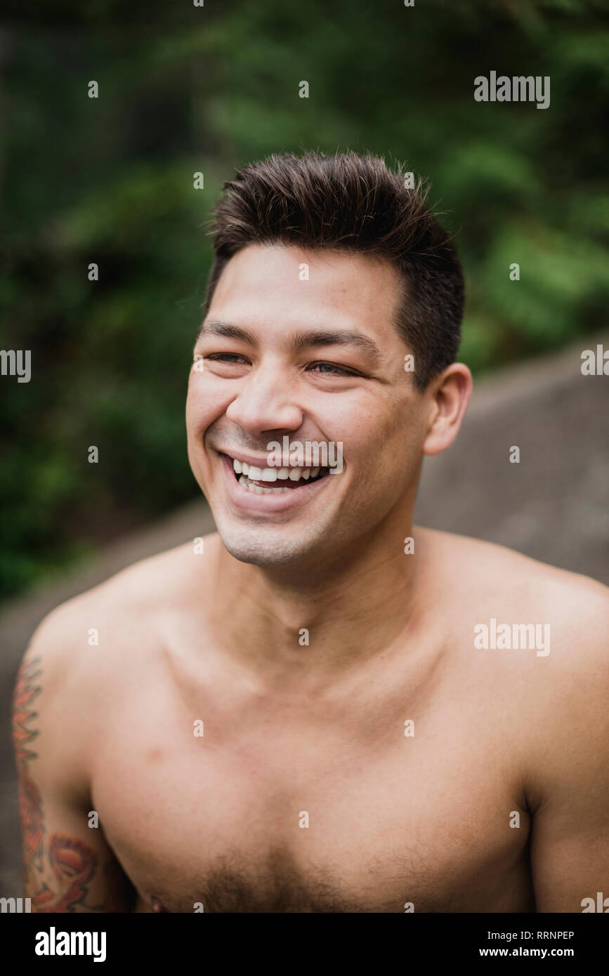 Portrait happy, handsome bare chested man laughing Stock Photo - Alamy
