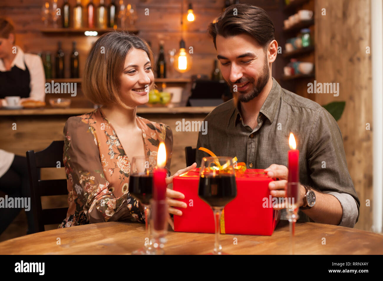 Young man looking happy after receiving a gift from his girlfriend ...