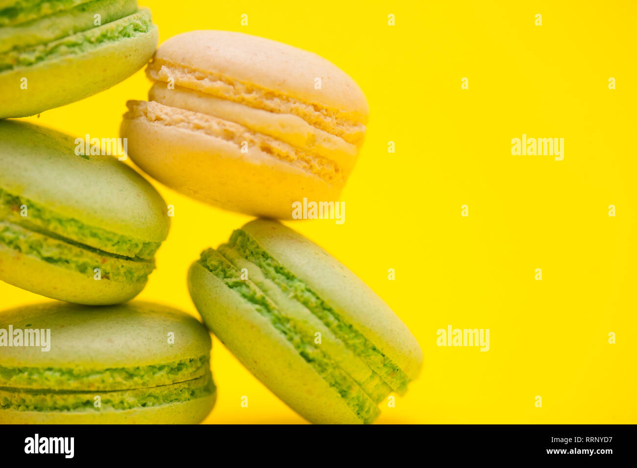 Macro sweet french macaroons over yellow background.Great desset Stock ...