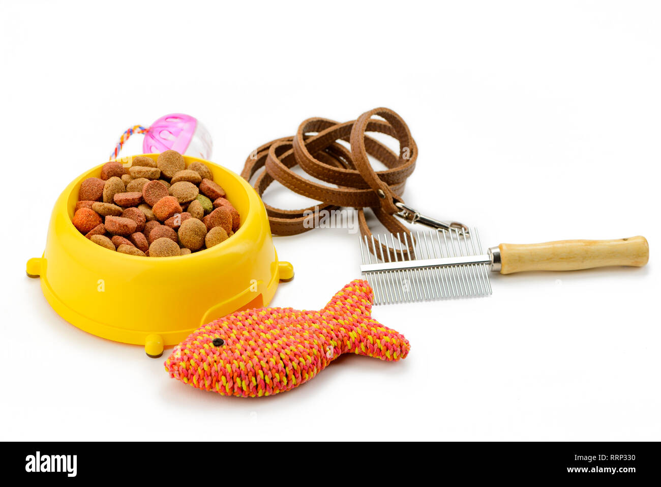 Cat food, brush and toys Stock Photo - Alamy