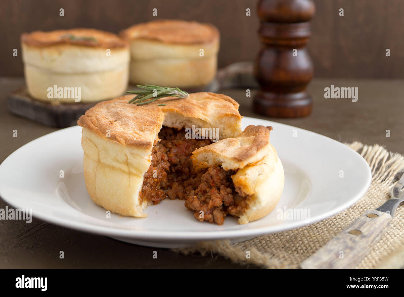 Australian meat pie on wooden table close-up with copy space, rustic ...