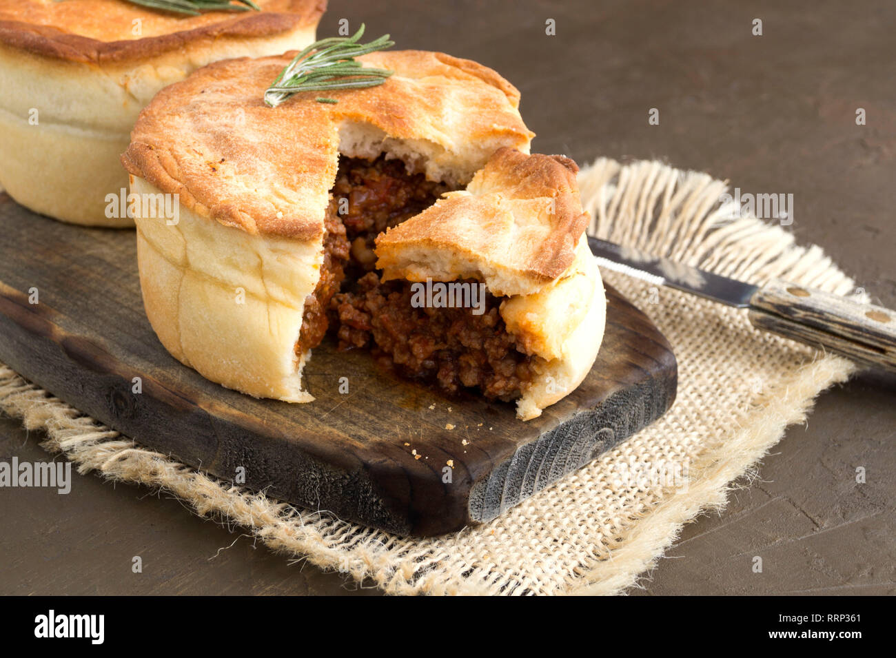 Australian meat pie on wooden table close-up with copy space, rustic ...