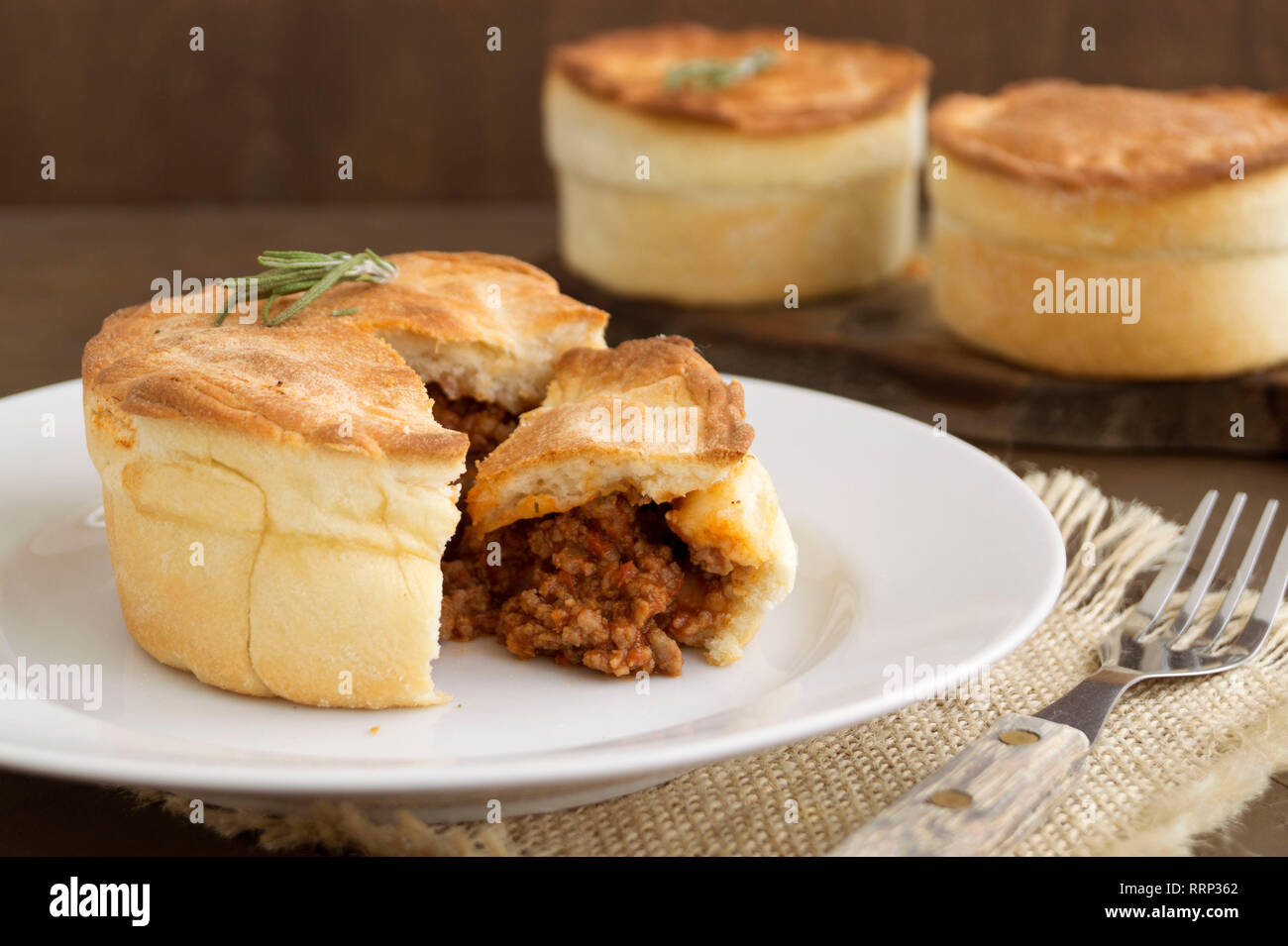 Australian meat pie on wooden table close-up with copy space, rustic ...