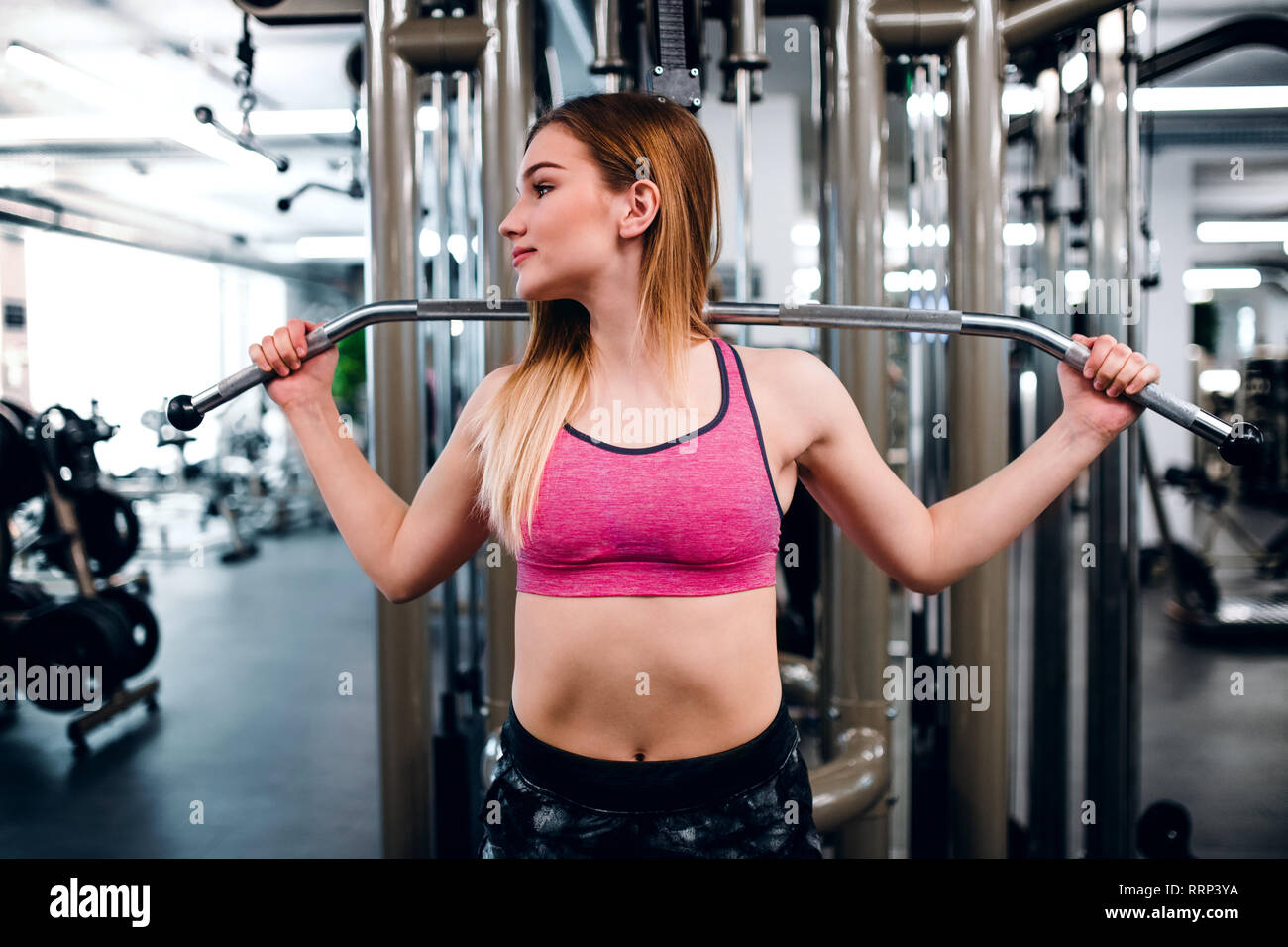 A front view of a beautiful young girl or woman doing strength workout ...