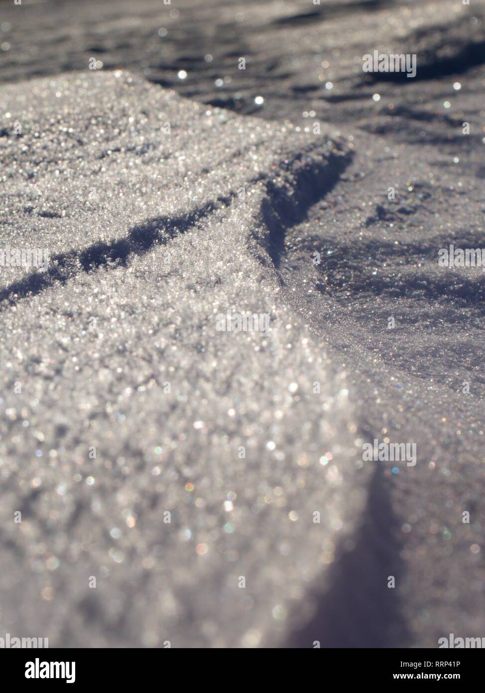 Snow ground with shadows and reflections. REal snow on a glass detail ...