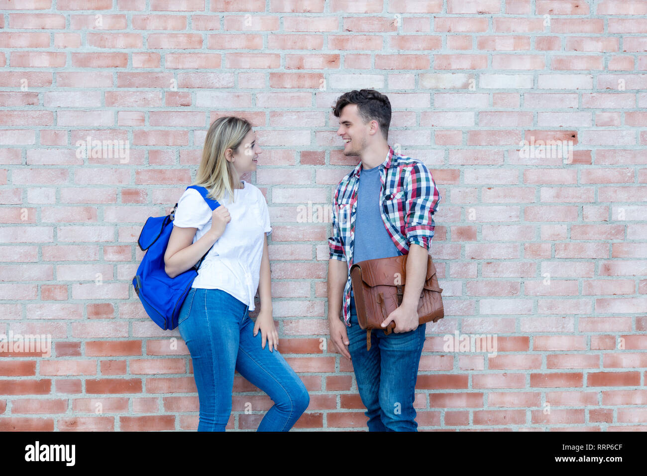 Two talking german male and female students outdoor on campus of ...