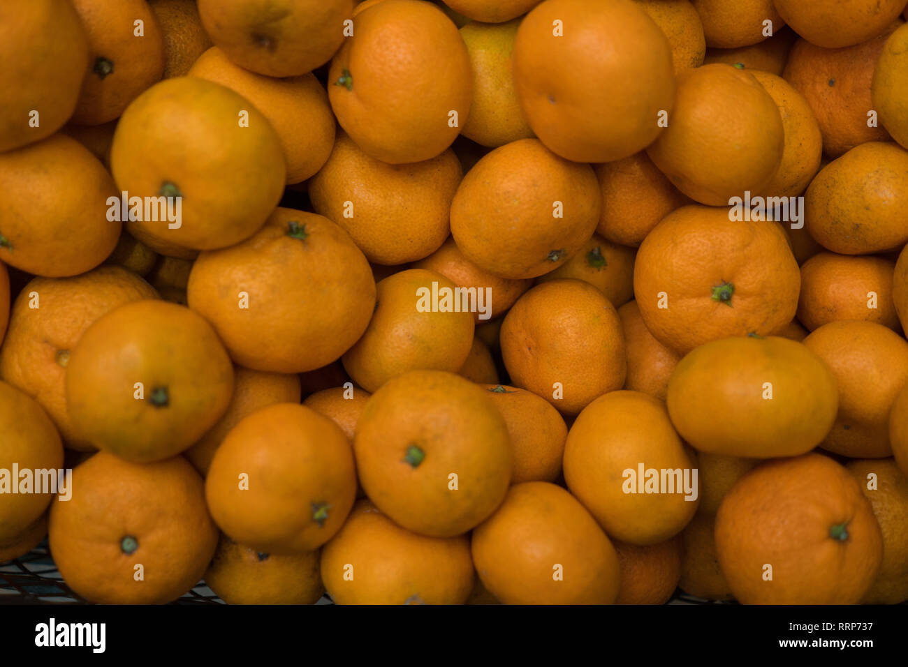 Many small ripe juicy mandarins in the box. Background Stock Photo - Alamy