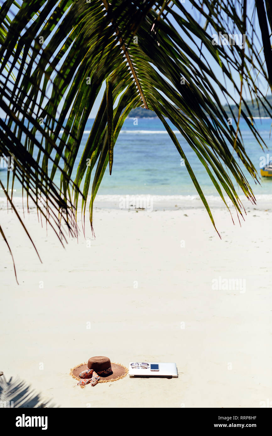 laptop and smartphone on beach. working and travelling on beach. remote ...