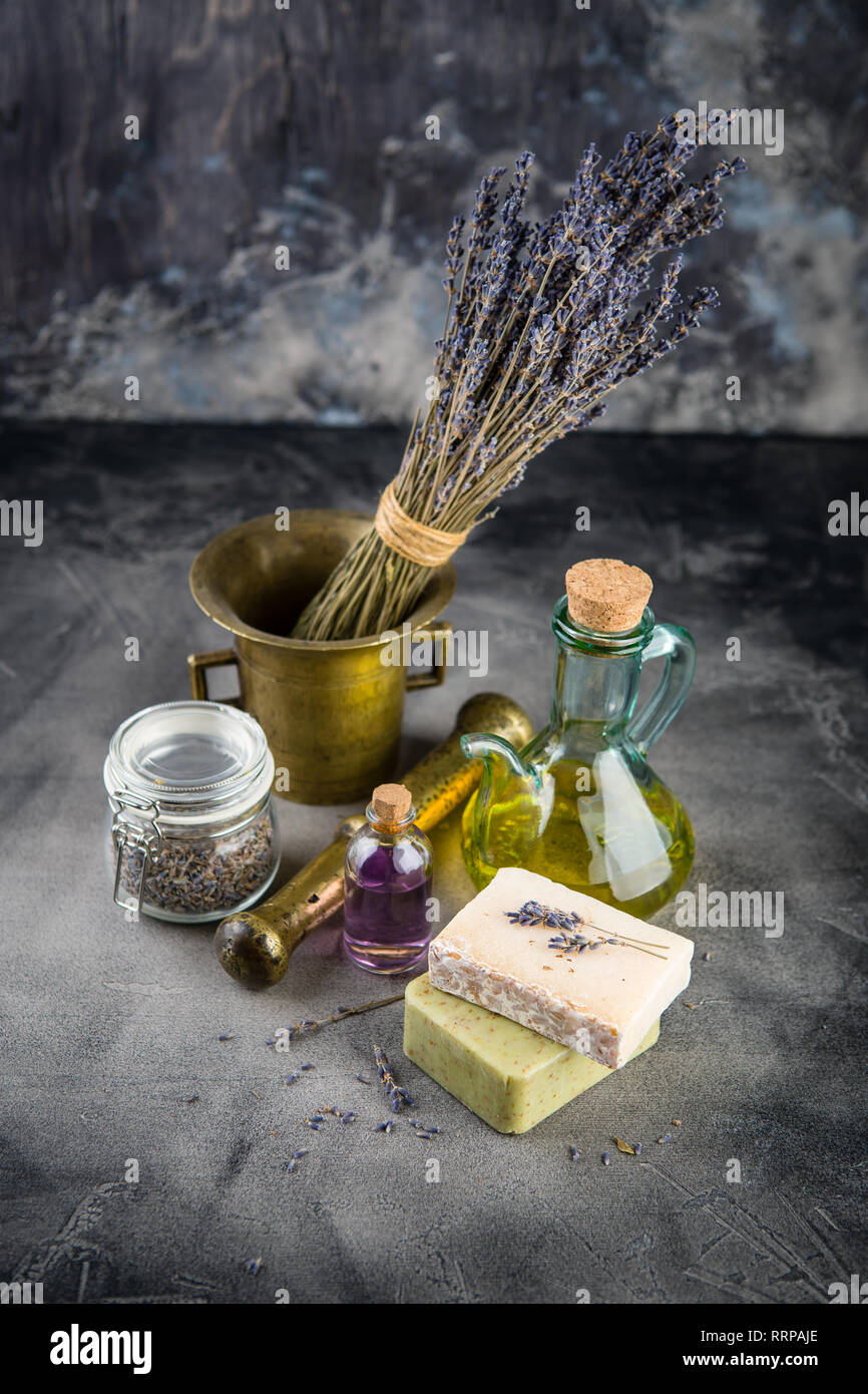 Bouquet of dry lavender,, a copper mortar with a pestle, pieces of homemade soap and oil for ...