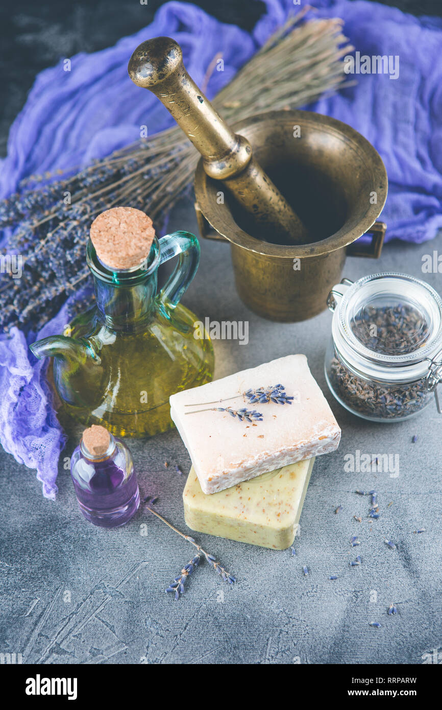 Bouquet of dry lavender,, a copper mortar with a pestle, pieces of homemade soap and oil for ...